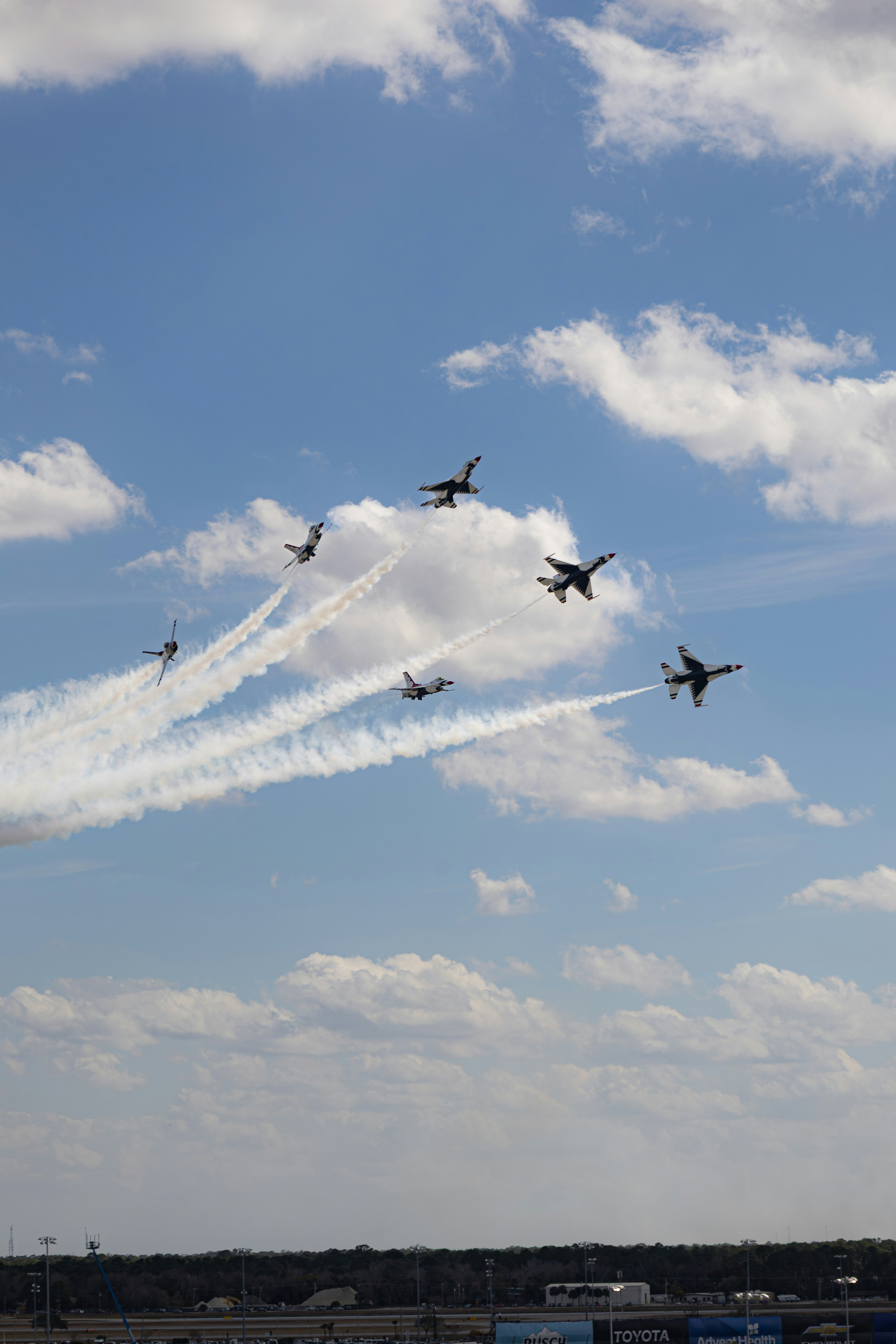 Skyward Accord: A flight of banners carving white trails across a cobalt sky