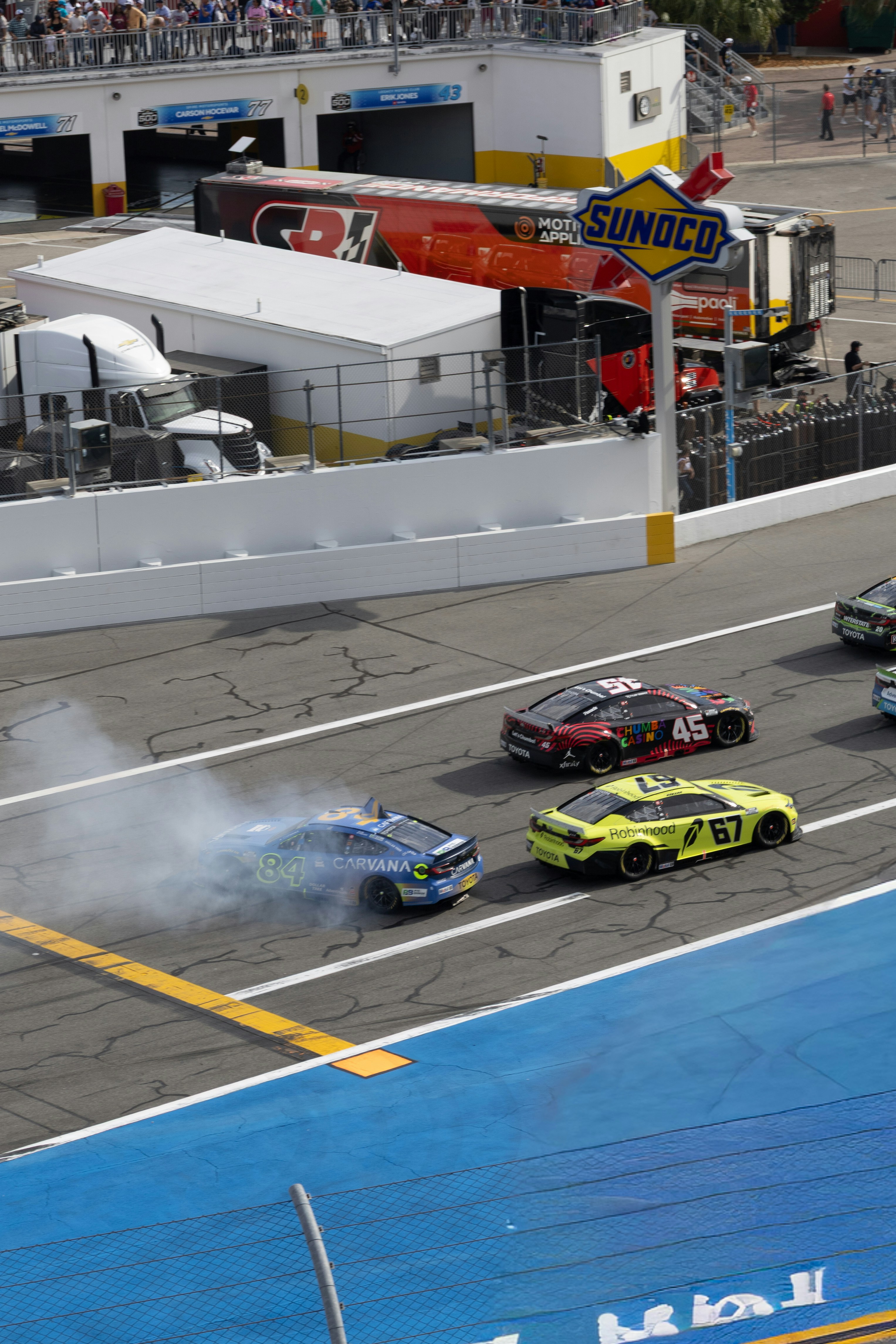 Smoky Sprint: Pack of Cars Races Toward the Wall