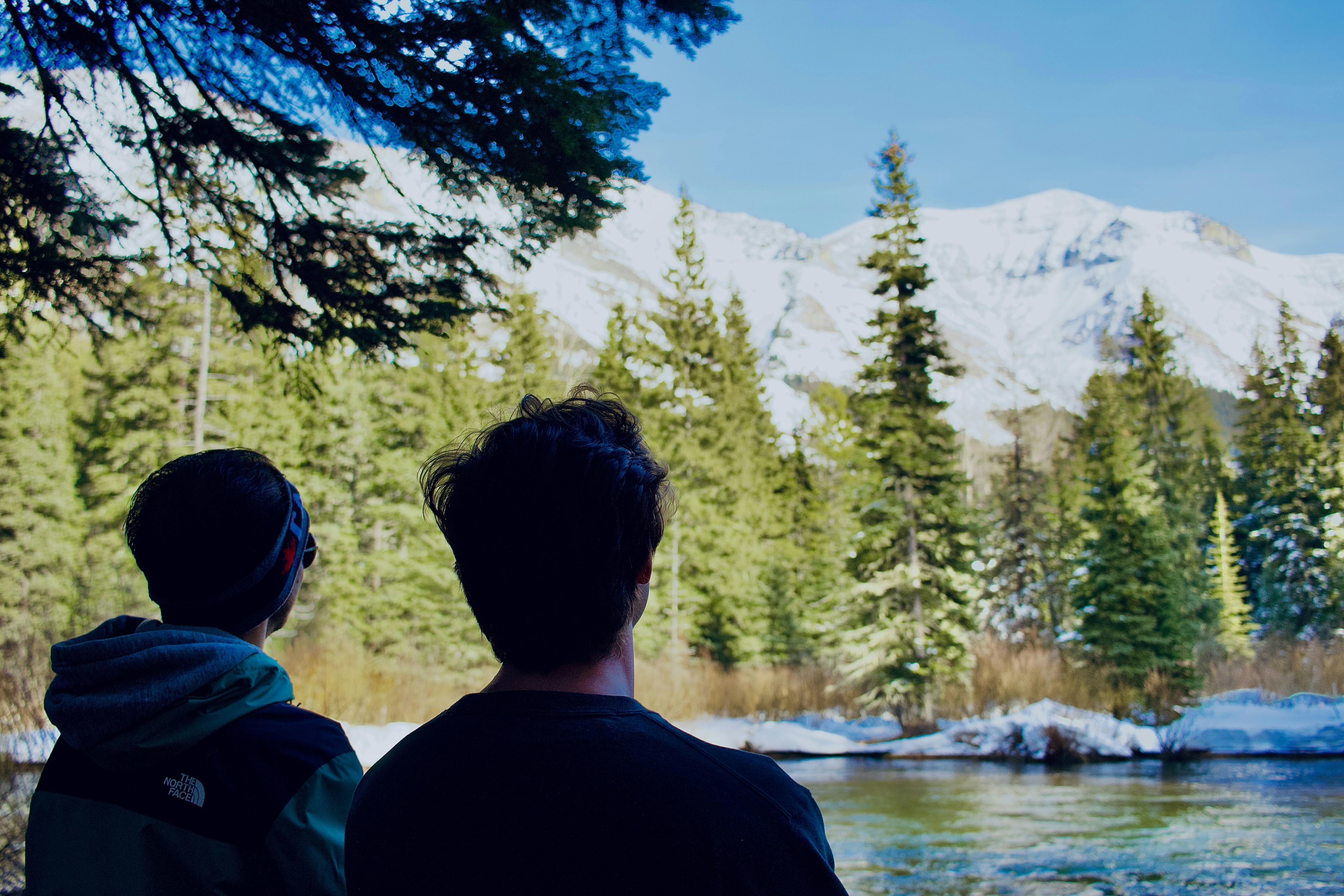 Two Observers at the Edge of a Snow-Capped Lake