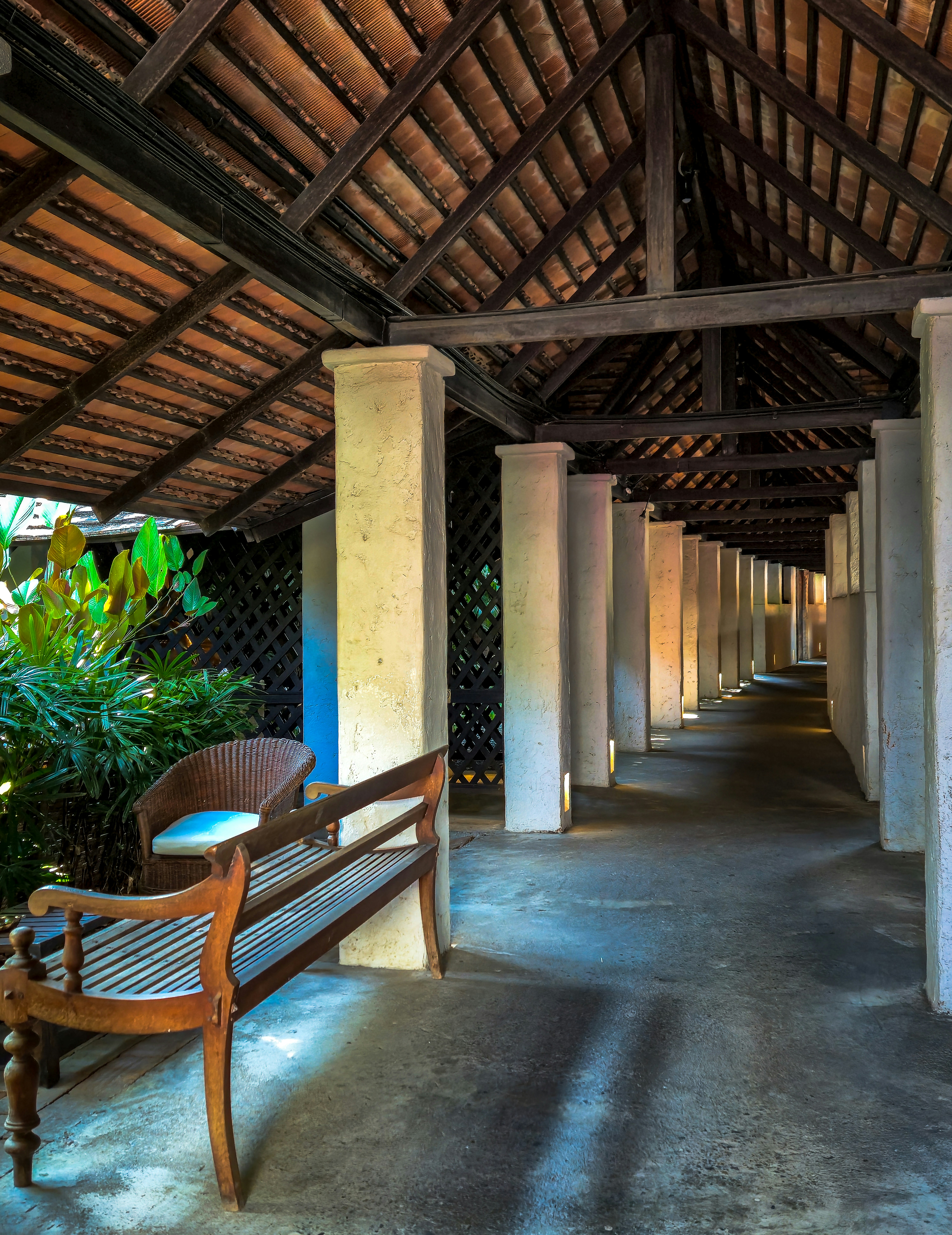 Sunlit Corridor of Columns: An Idle Veranda in Dappled Light