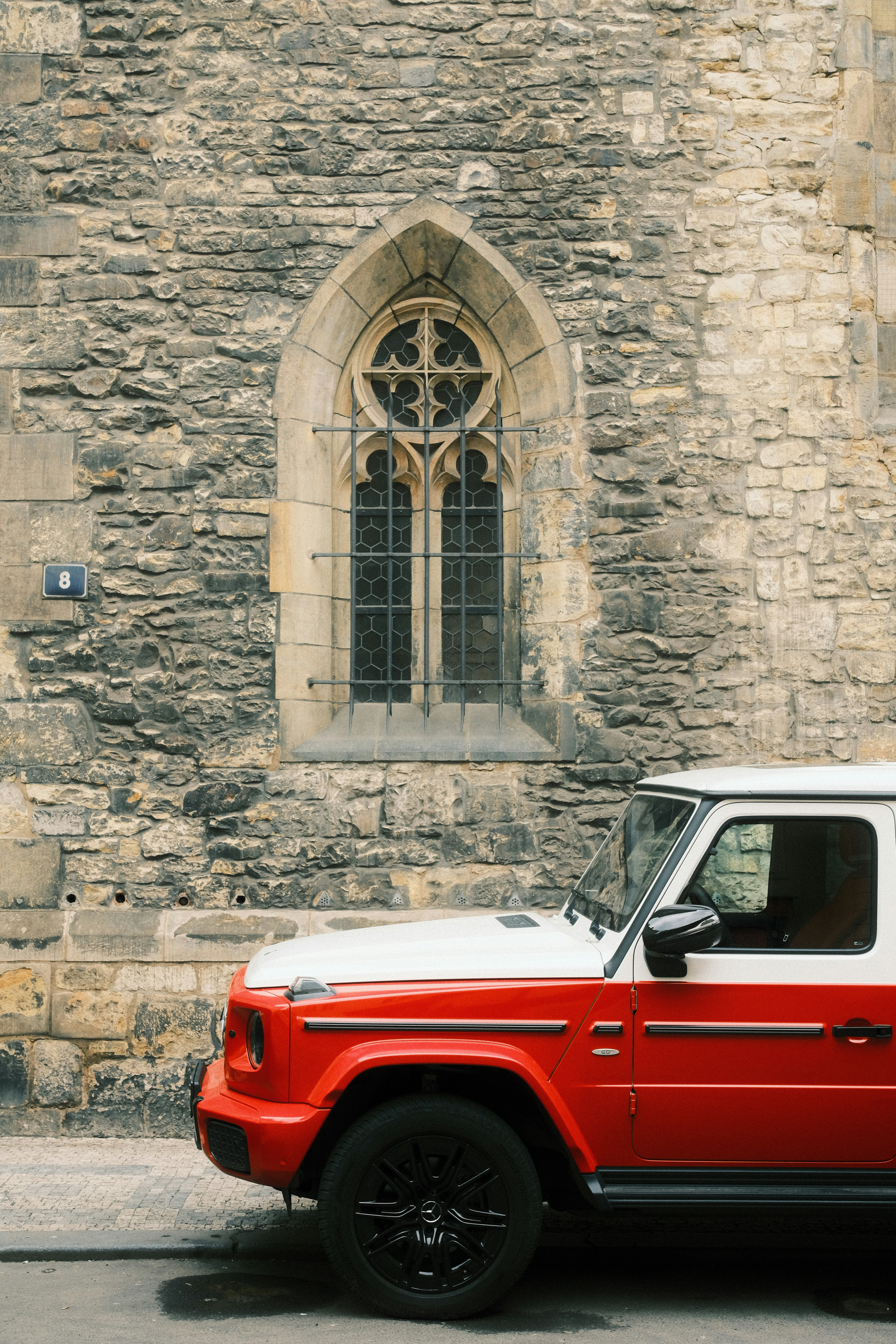 Red Sedan at the Foot of a Gothic Window