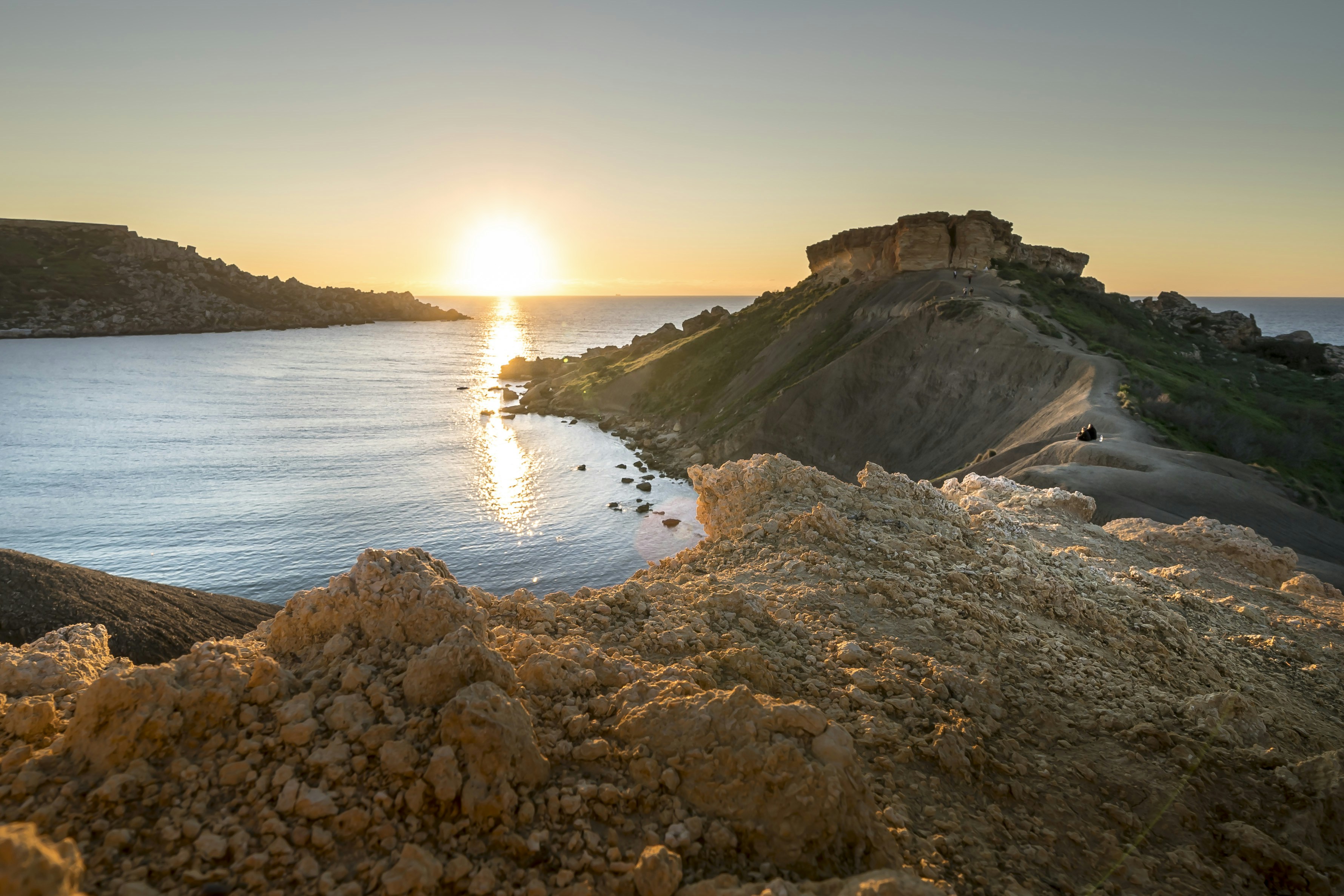 Sunlit Cape: Cliffside Formation at Dusk