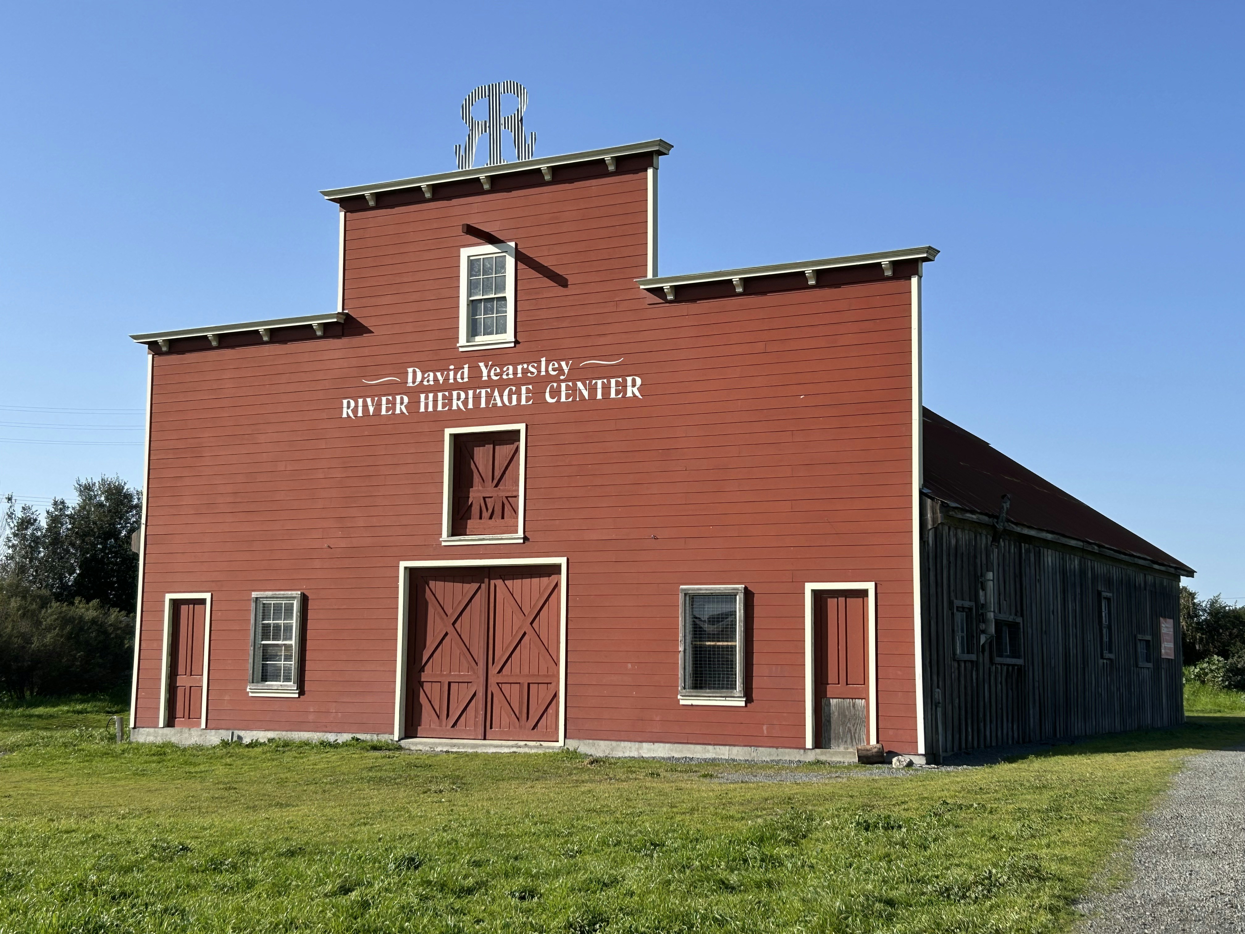 Ranch House Barn: A Red Heritage Building Under a Clear Blue Sky