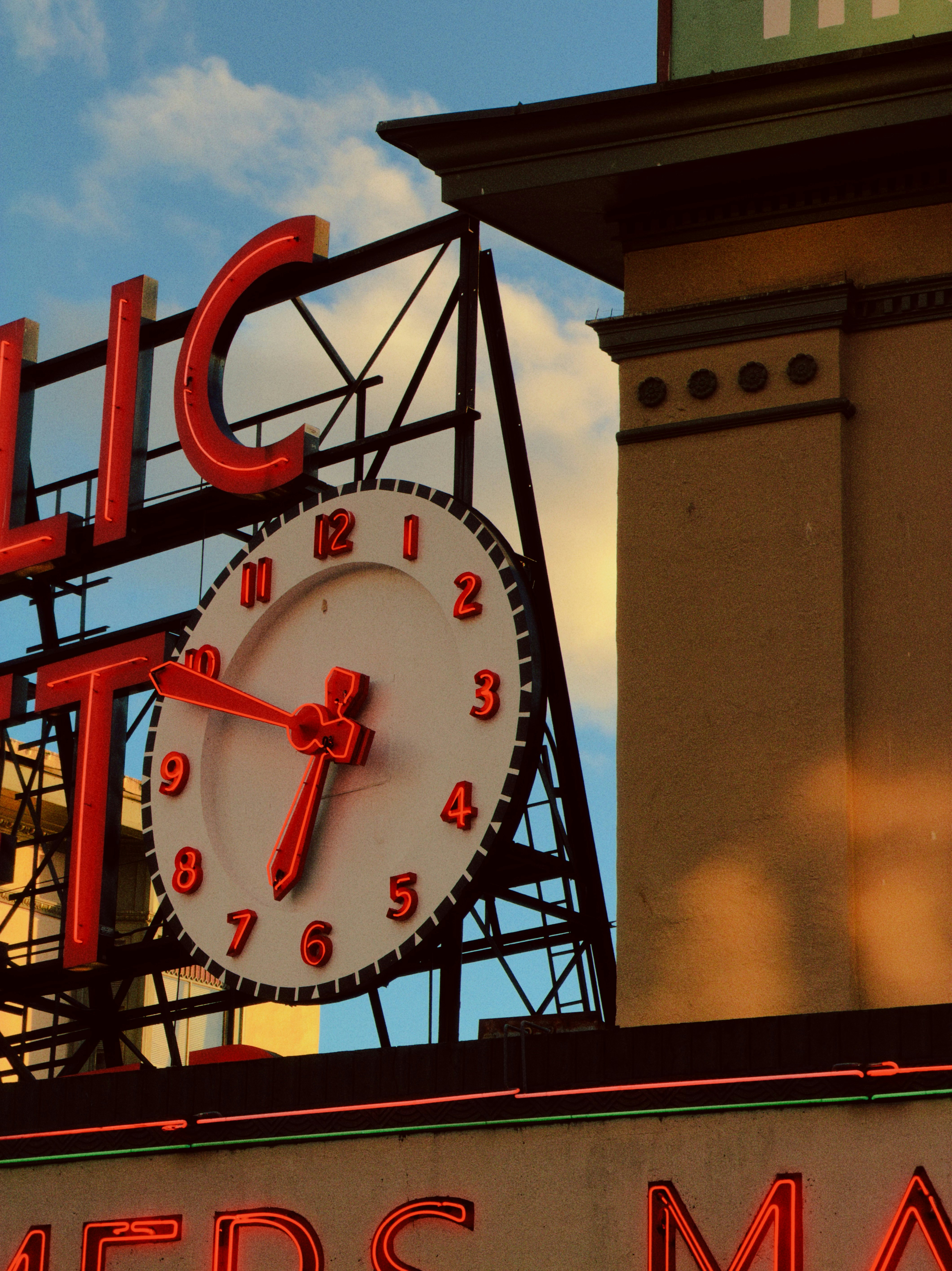 Neon Clock at Dusk: Retro Signage and Tower Face