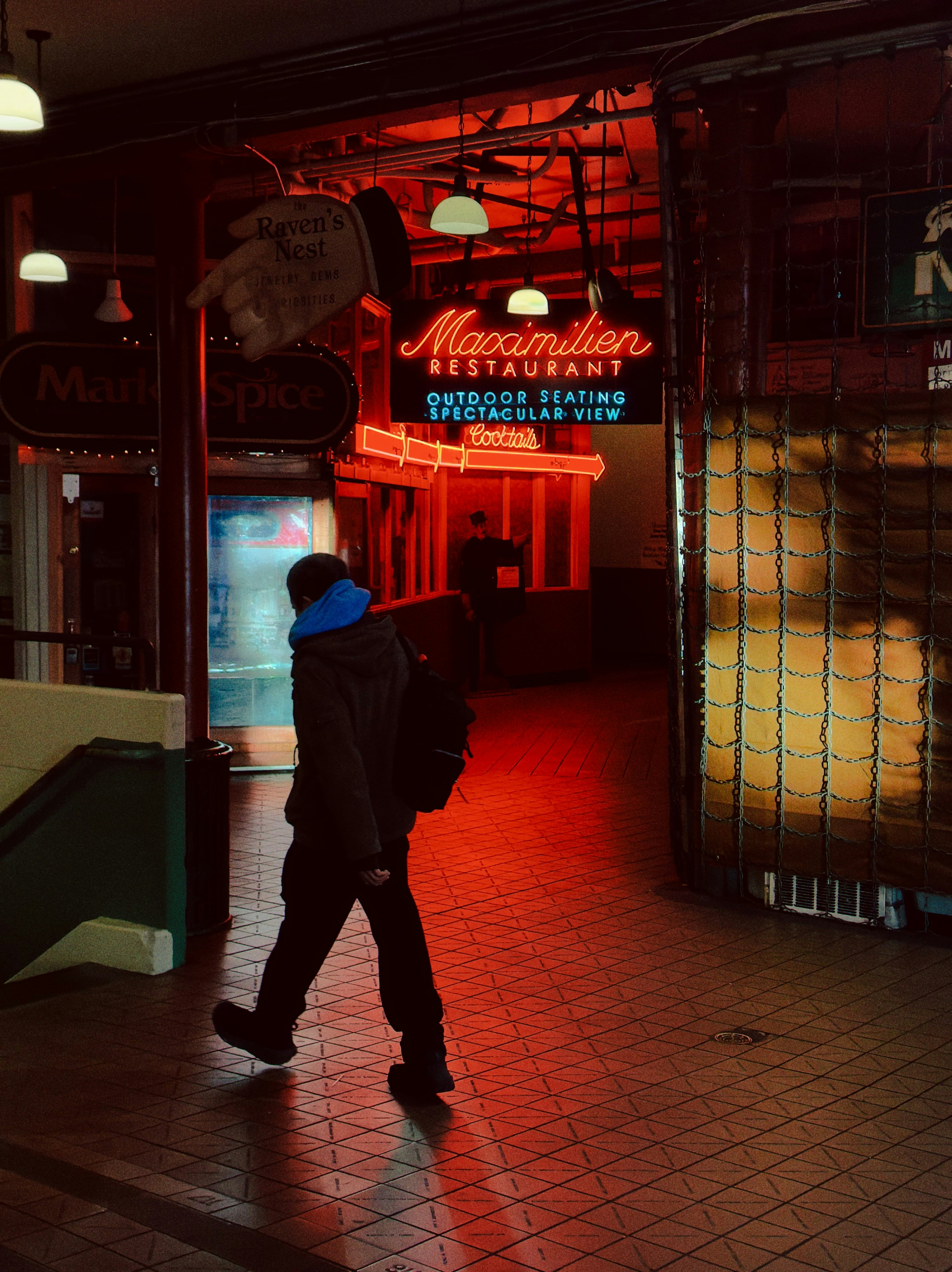 Neon Alley Trek: A figure under crimson signage
