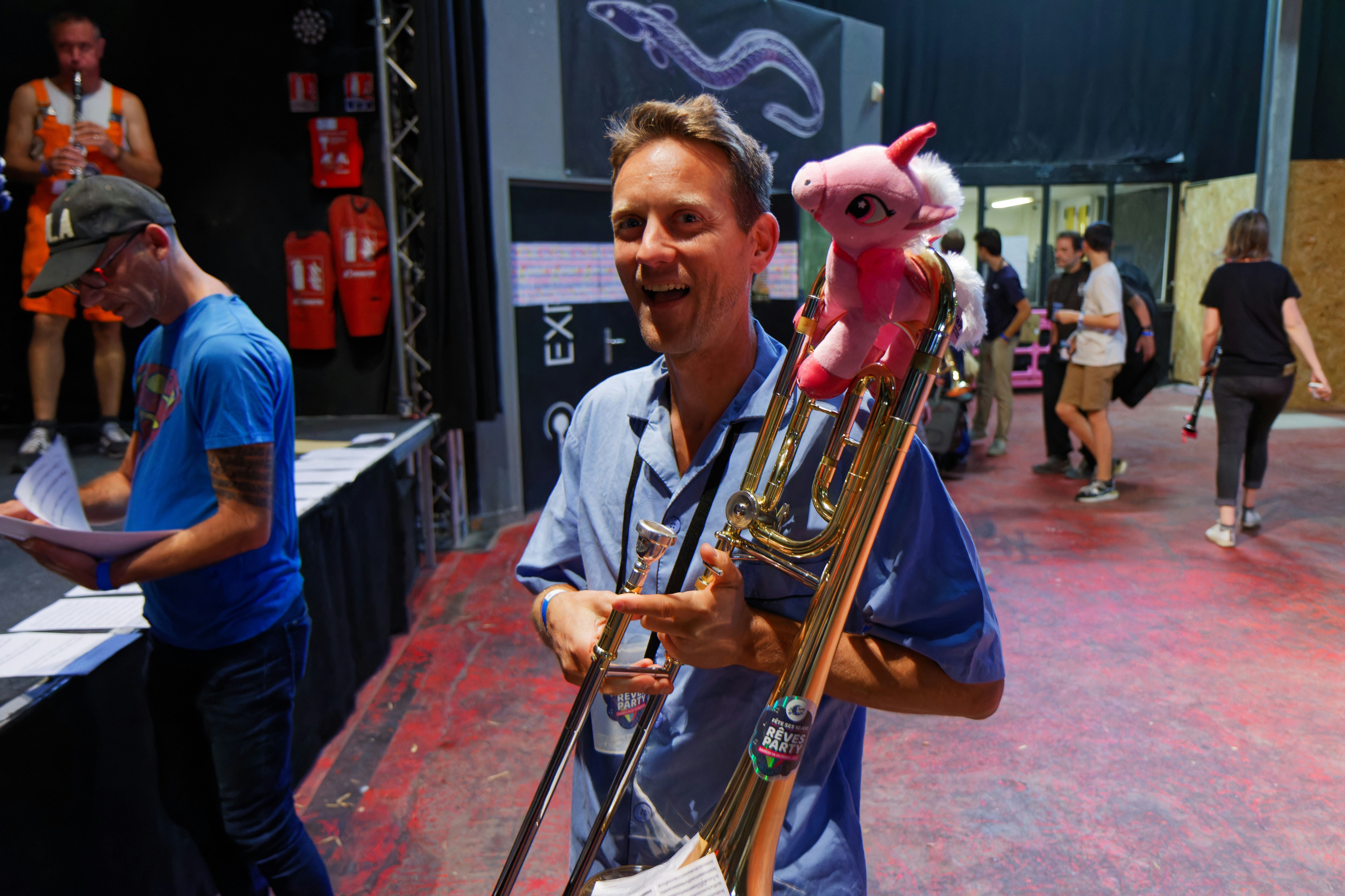 Trombone Triumph: A Performer Celebrates with a Plush Mascot