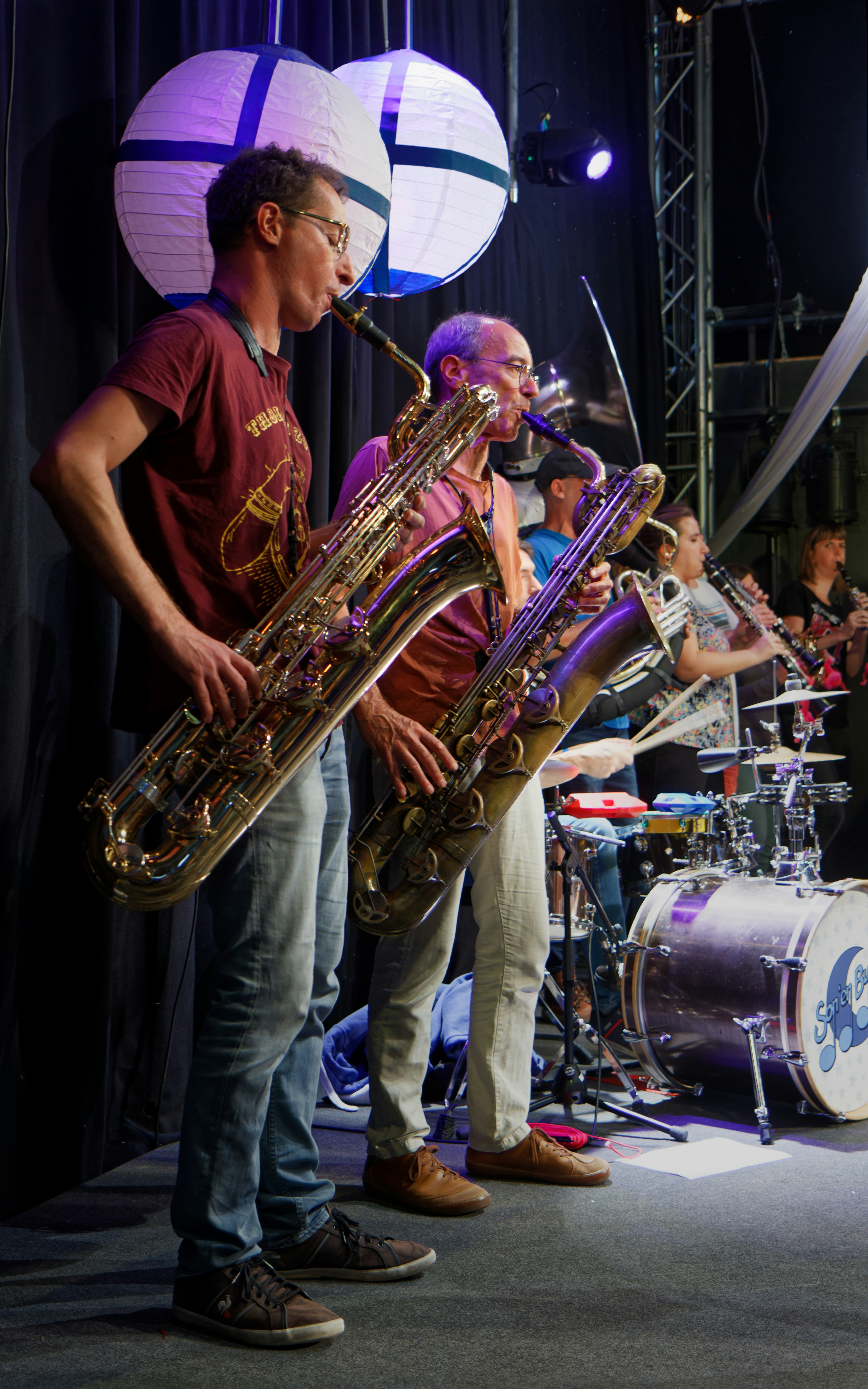 Brass in Motion: a jazz line of saxophones under stage lanterns
