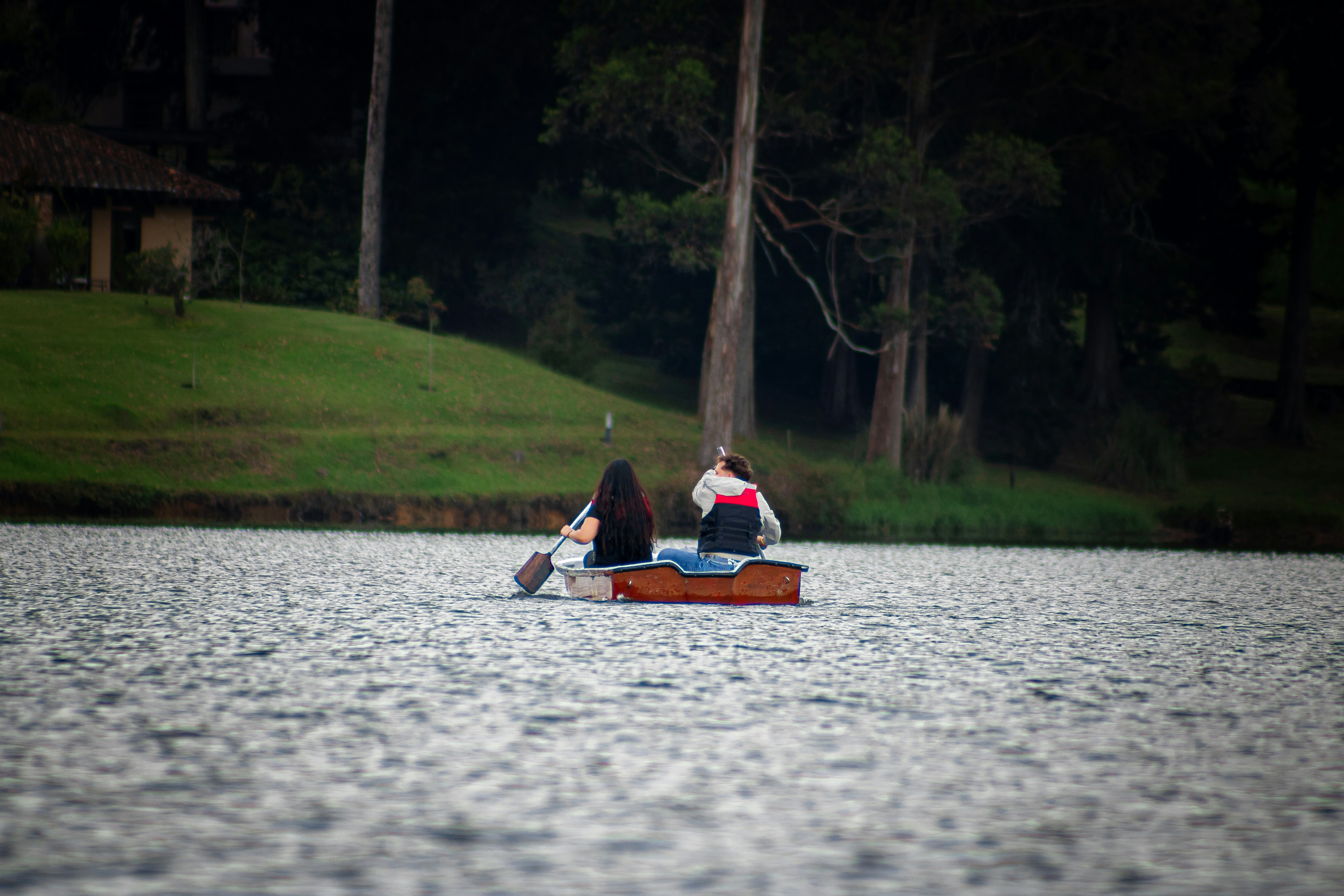 Rowing Couple in a Small Boat on a Calm Lake