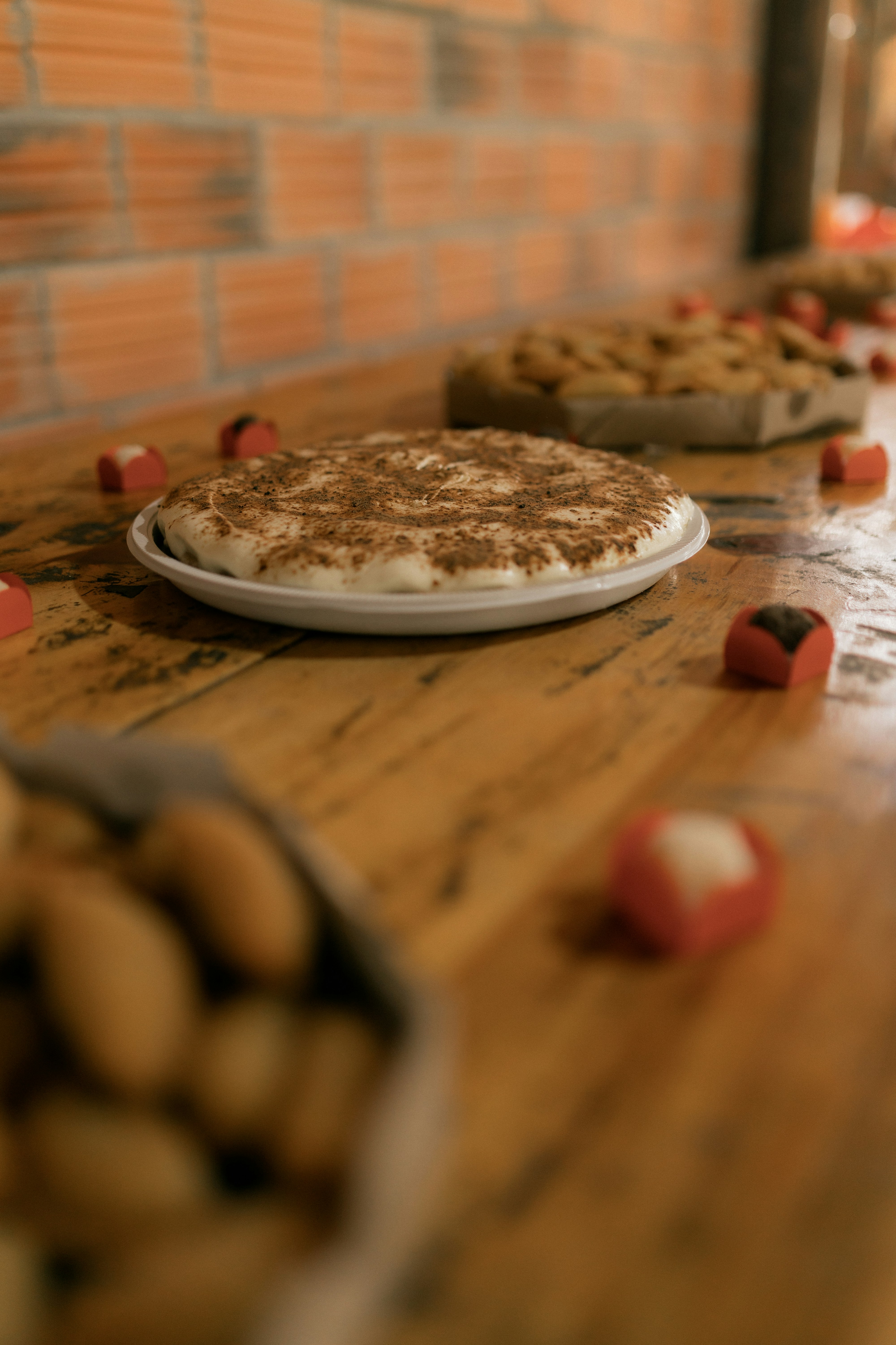 Underside of a Creamy Tart on a Rustic Table with Chocolate Dust