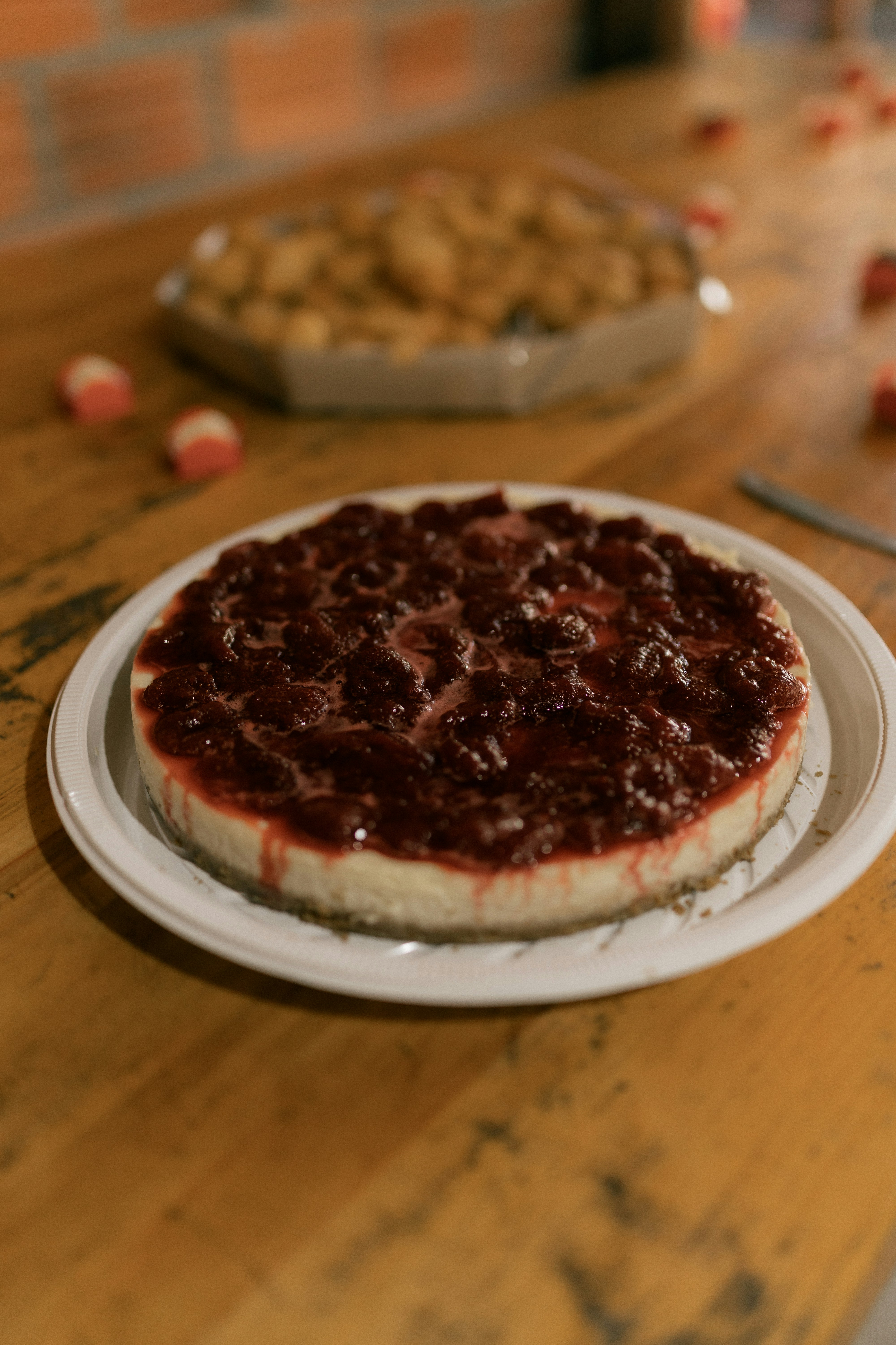 Cherry-Topped Cheesecake on a Rustic Wooden Table