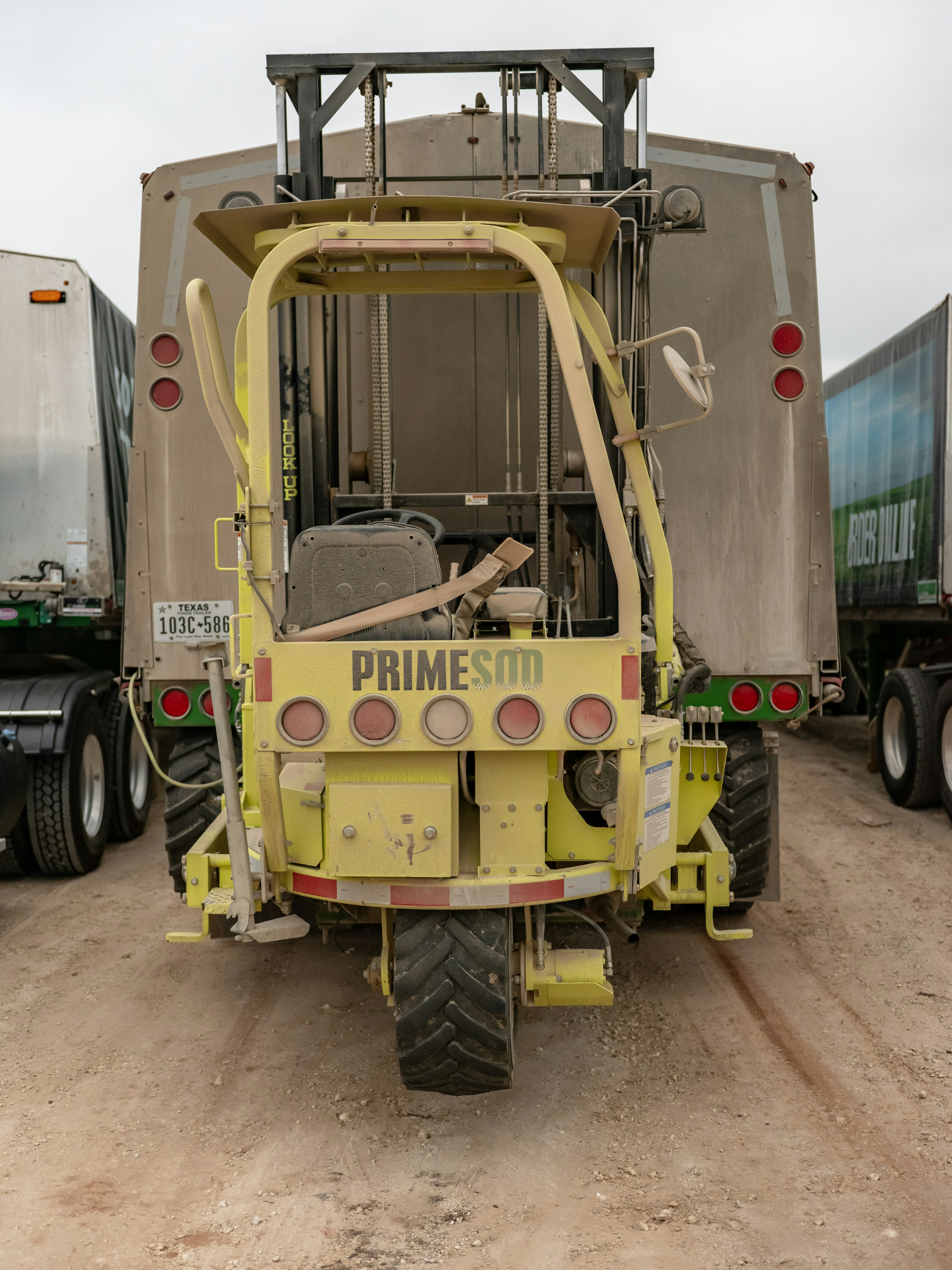 Yellow Forklift Trailer Stacked with Iron Duty in a Commercial Yard