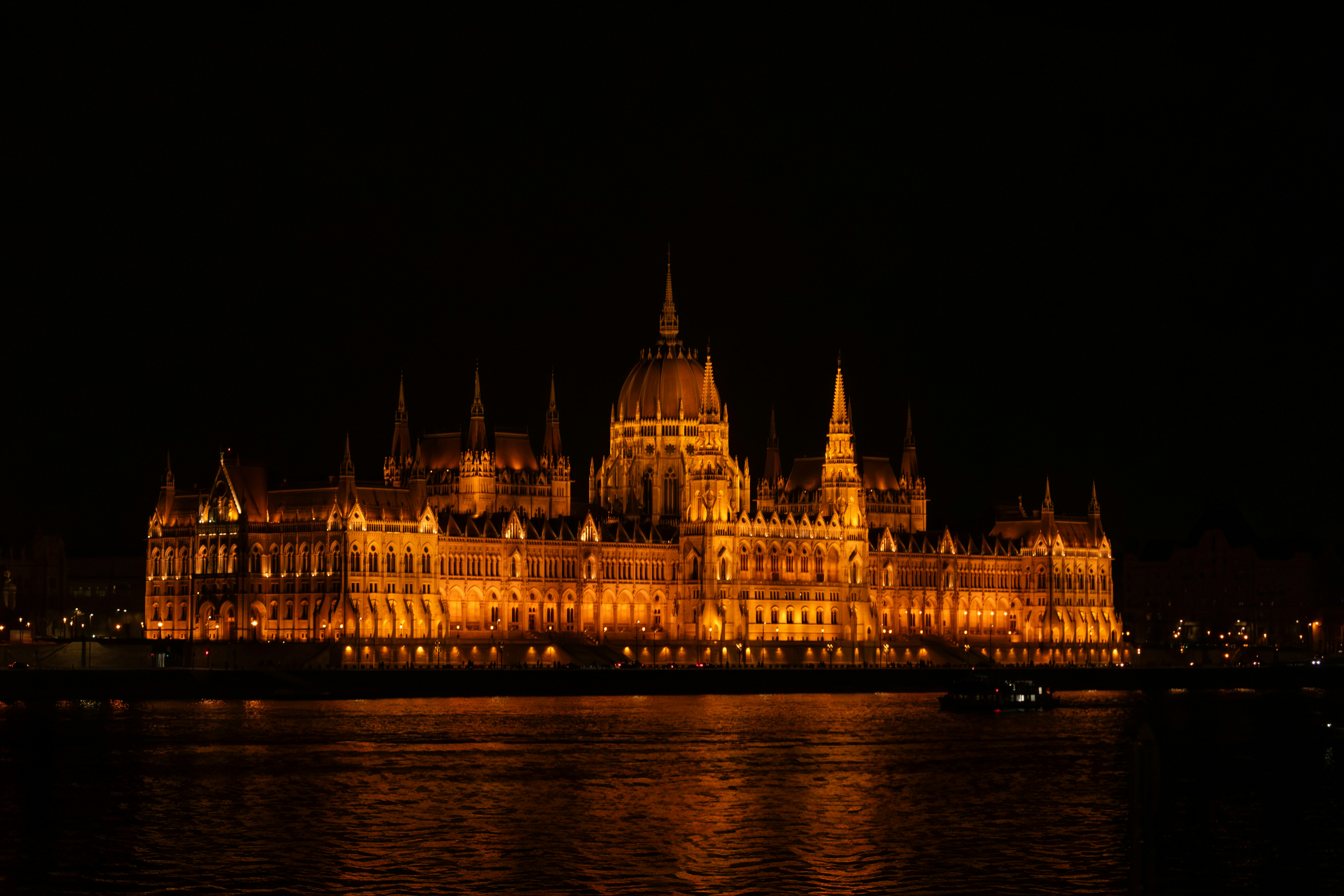 Golden Shadows: Illuminated Parliament House Rising from the Dark Waters