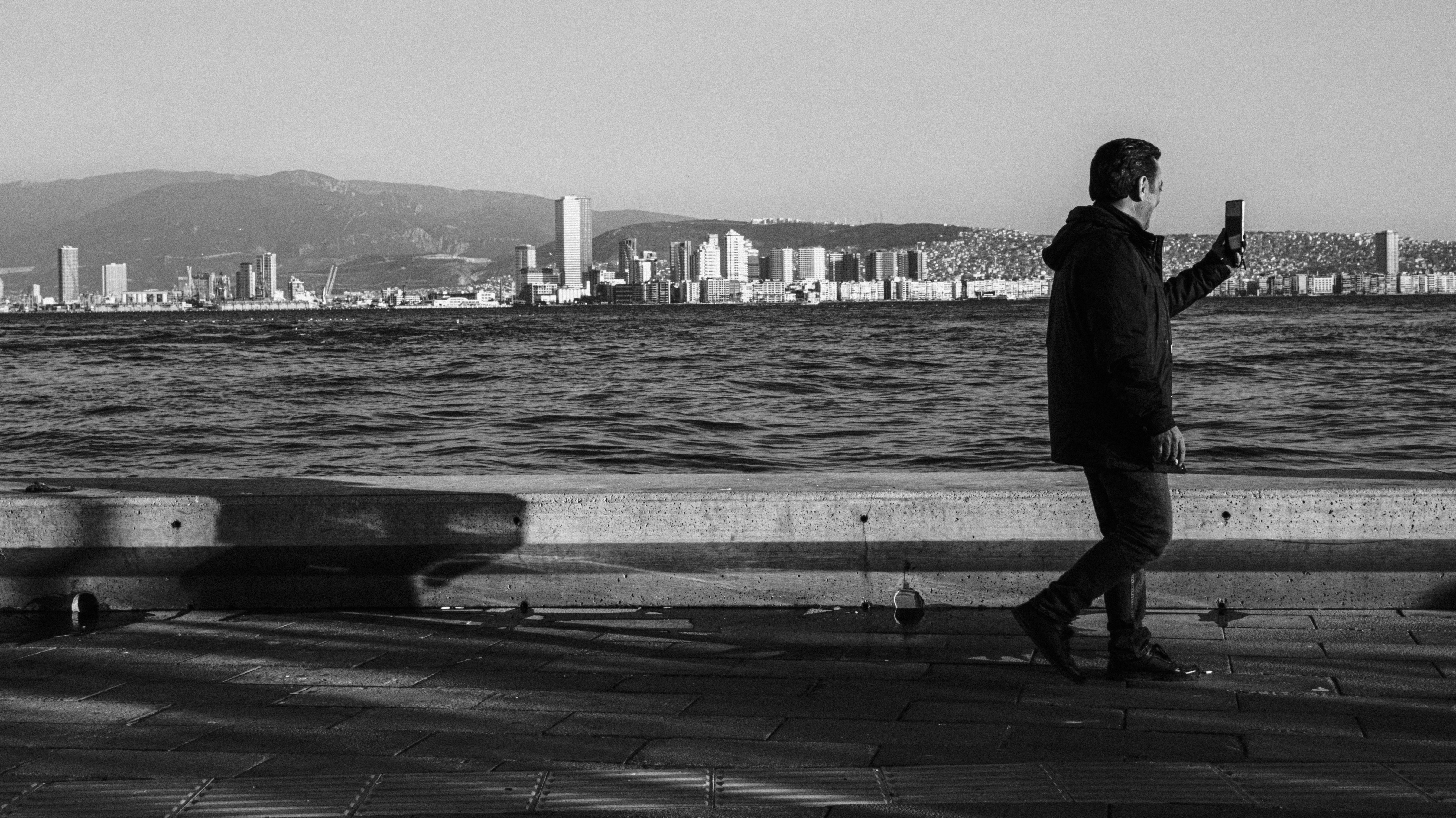 Selfie on the Waterfront: A Distant City Framed by Waves