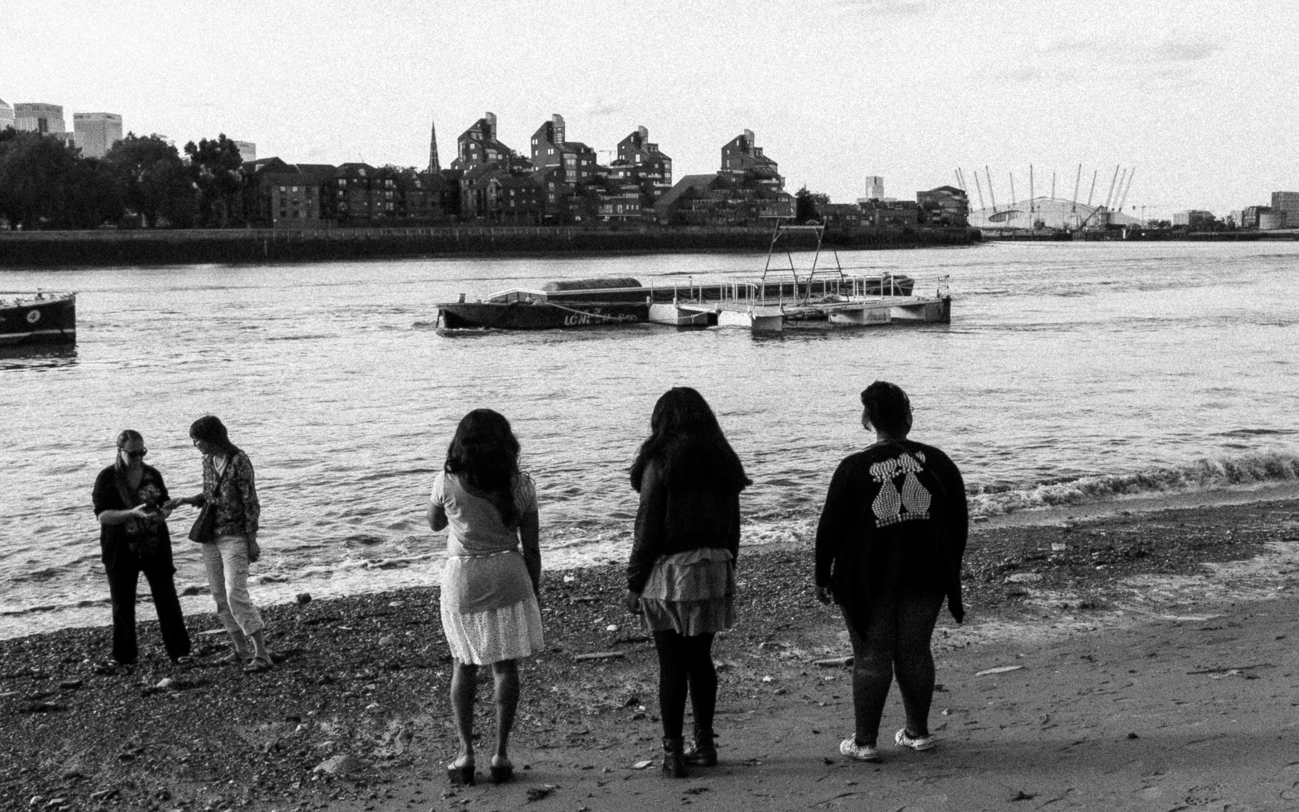 Shoreline Quartet: Shadowed Figures by the Riverbank