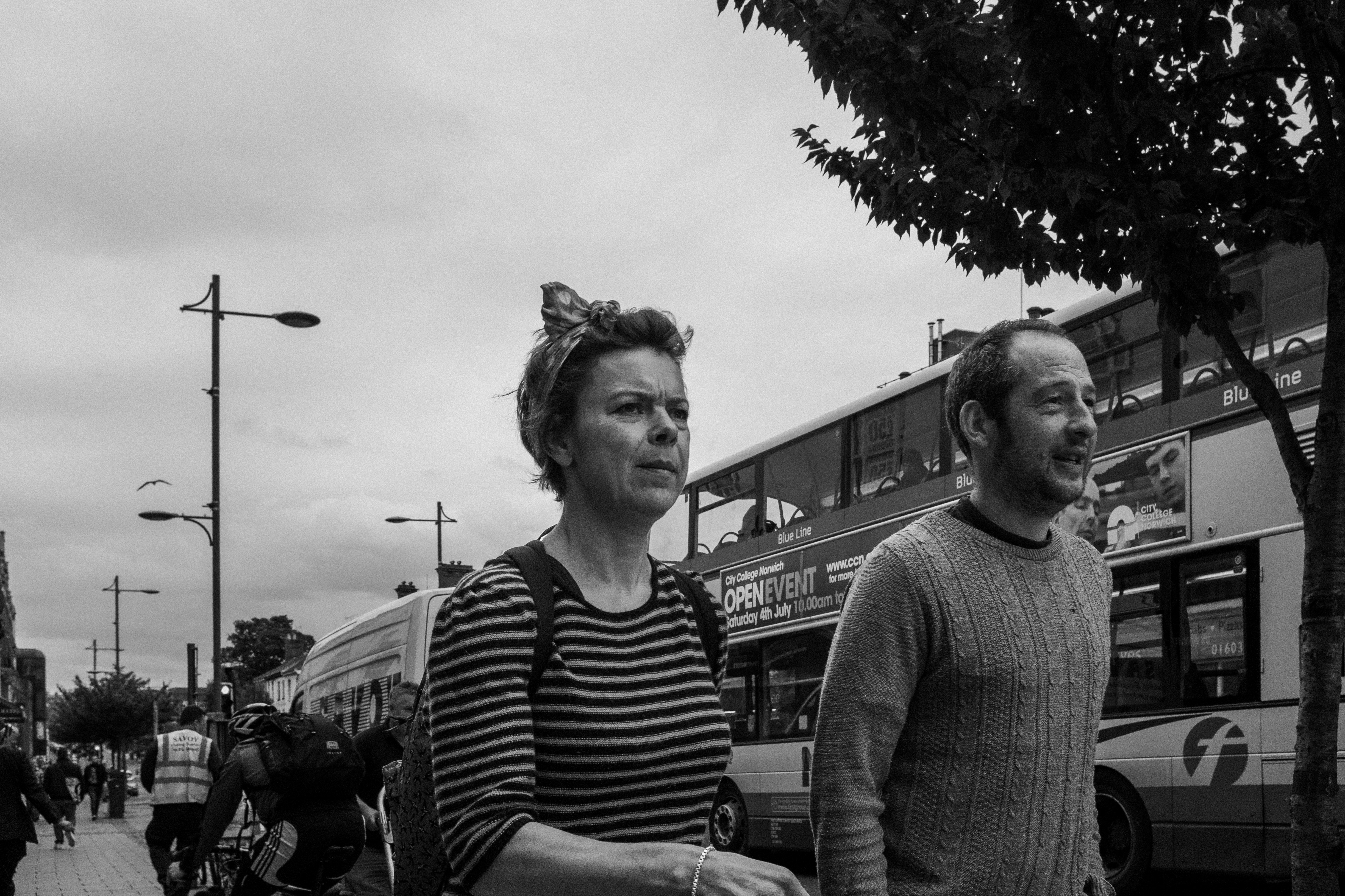 Two Passersby at a Bus Stop: Quiet Tension Beneath a City Pedestrian Quiet