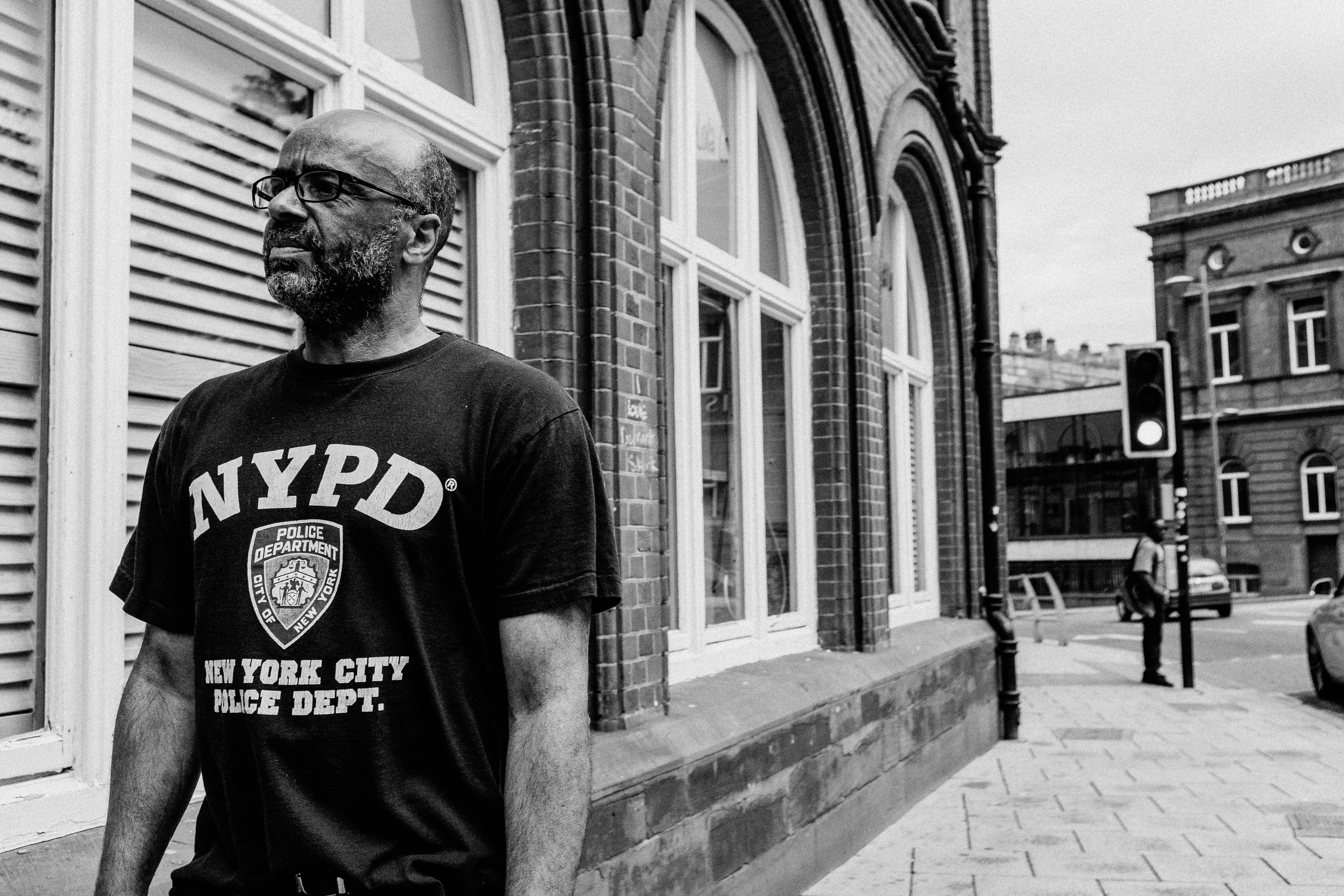 NYPD T-shirted Figure at a City Corner