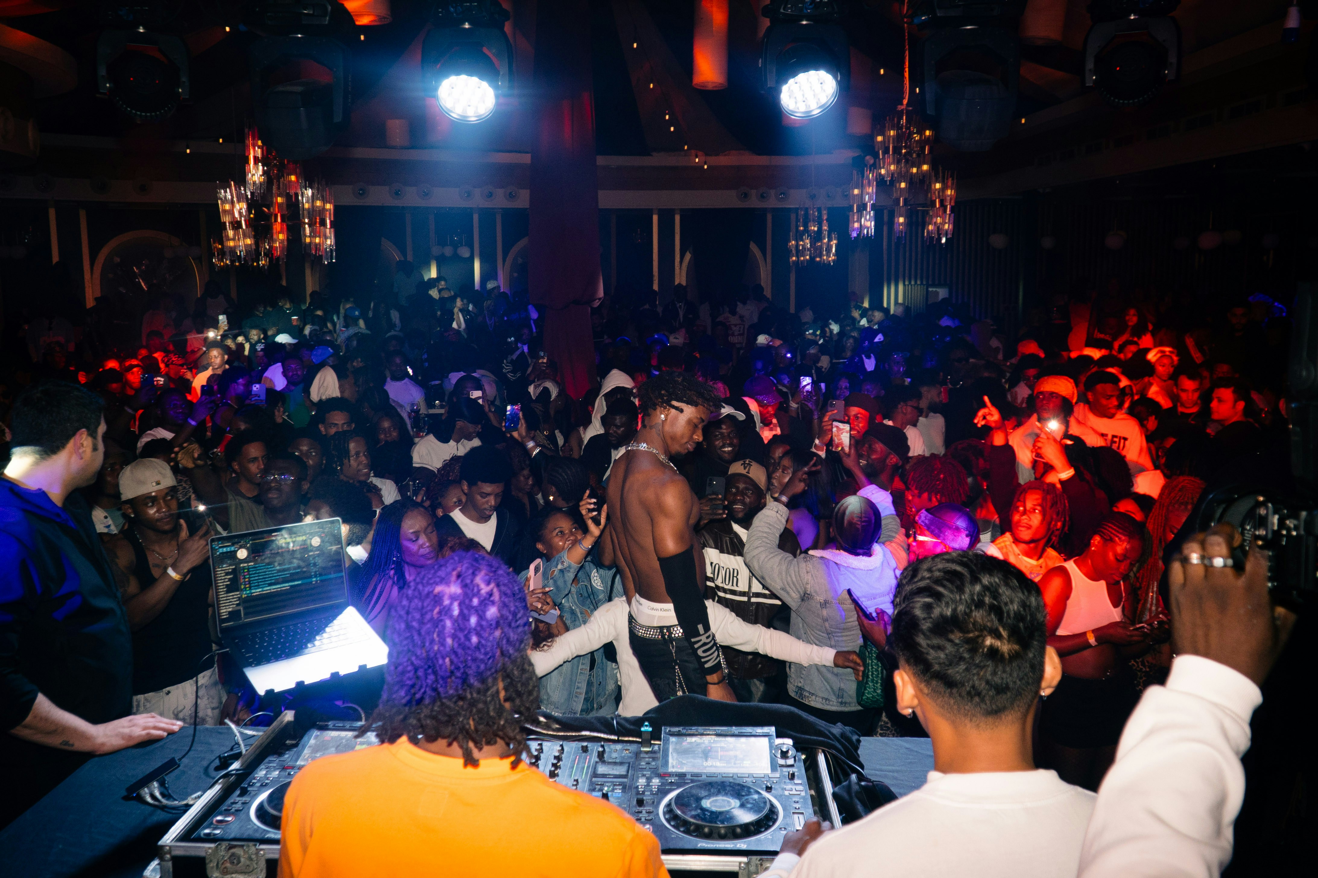 Midnight Pulse: The DJ’s Console Beckons the Crowd