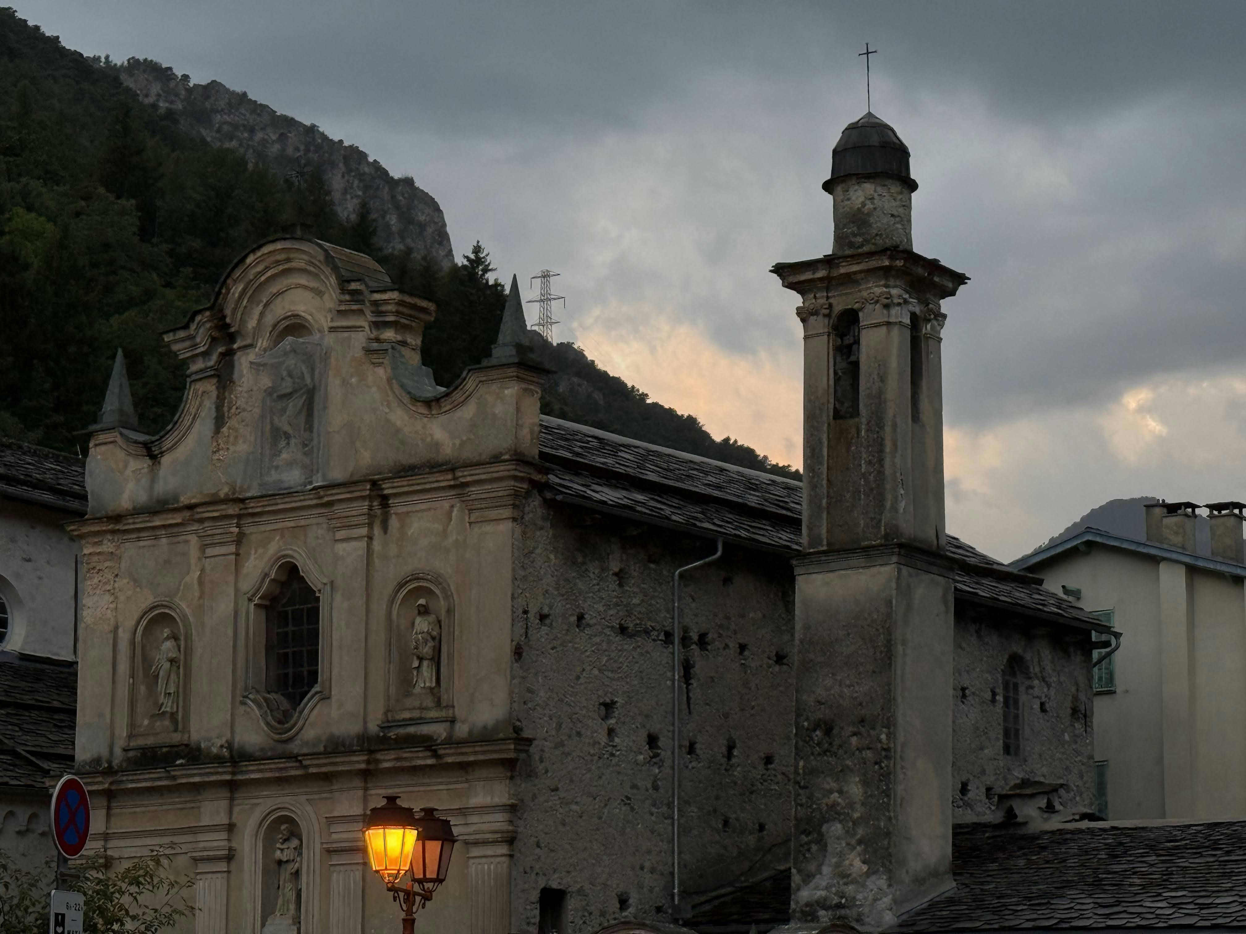 Sunlit Facade and Lanterns: An Alpine Chapel Moment