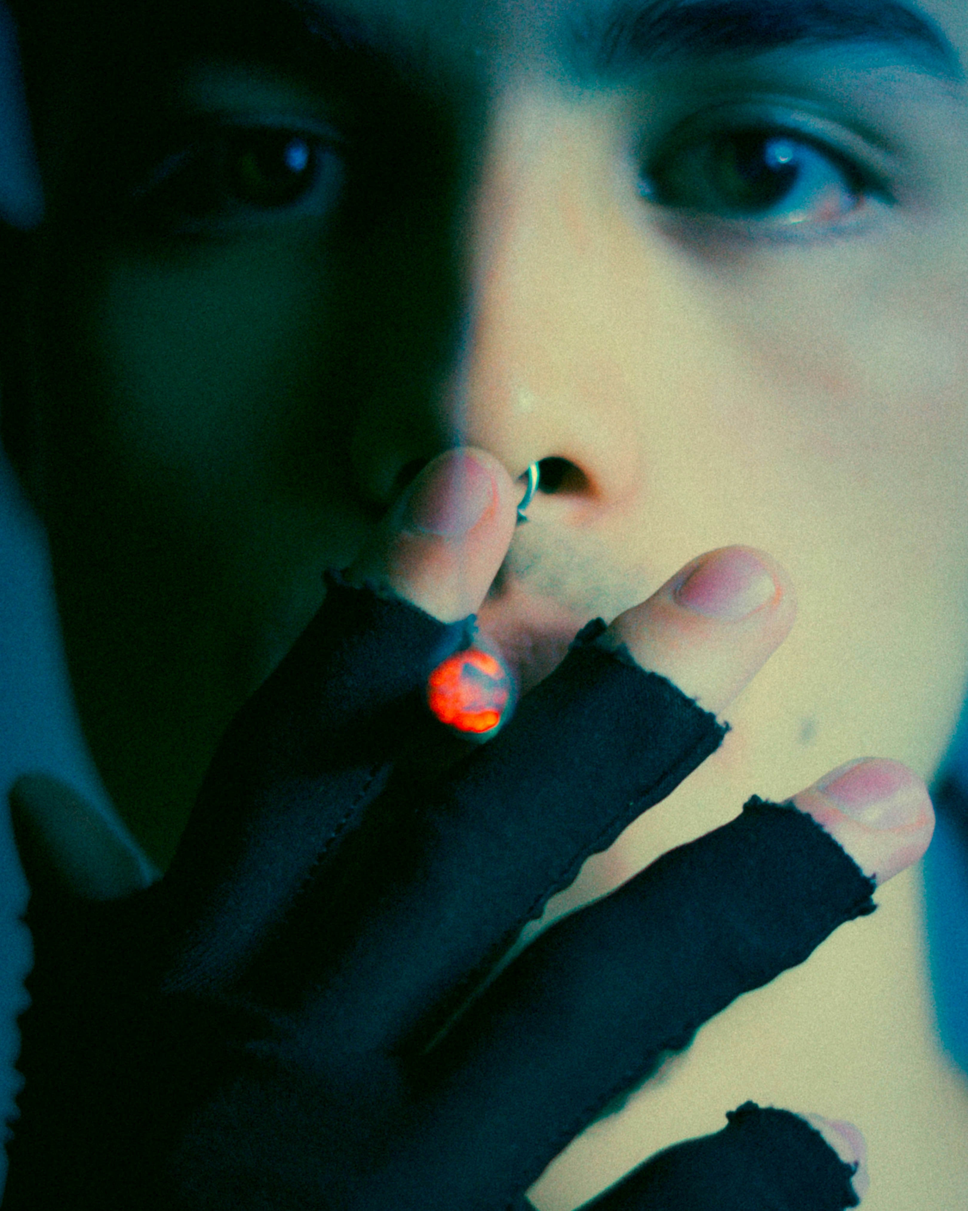 Smoldering Gaze Behind a Gloved Fingertip