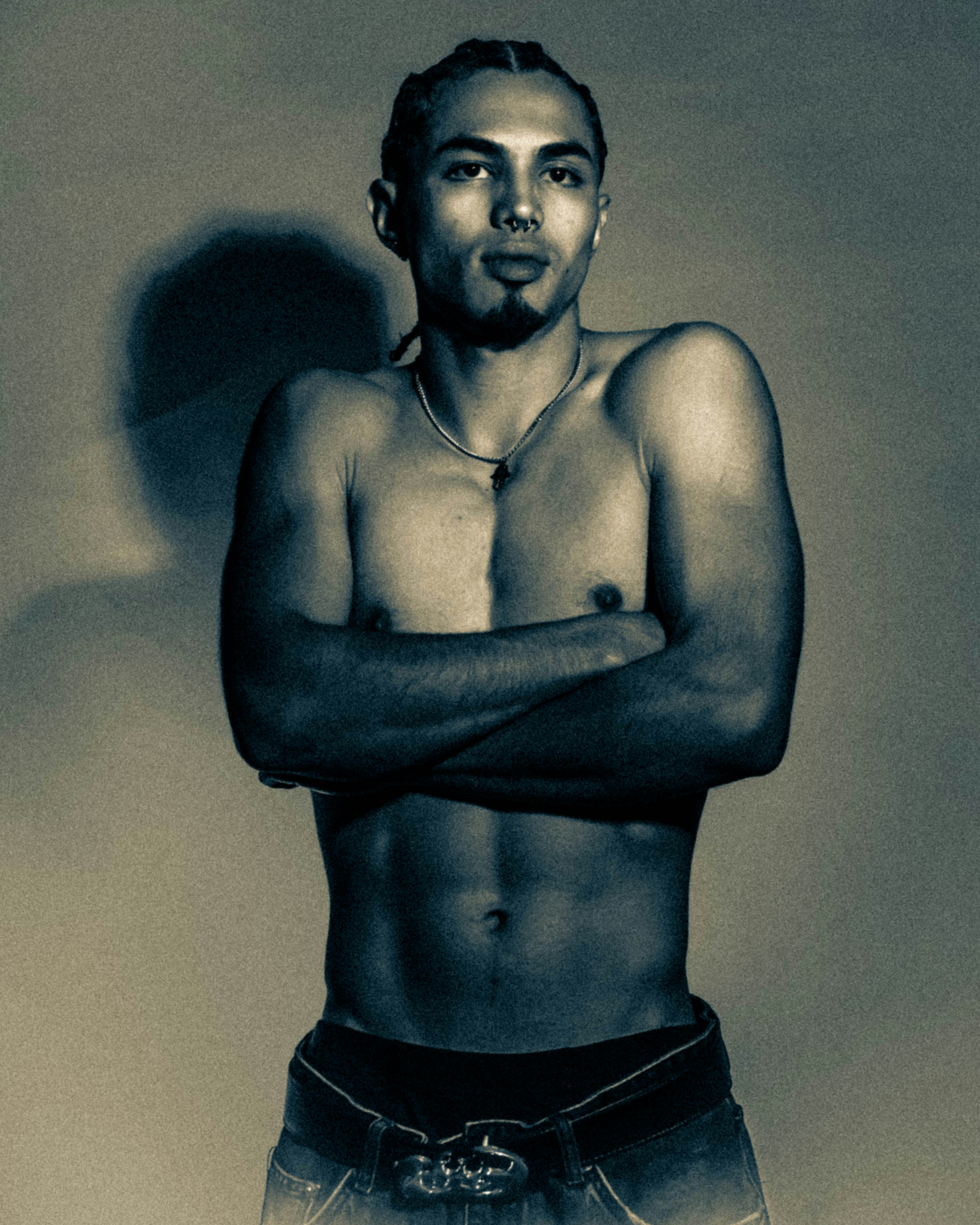 Crossed Arms, Quiet Confidence: A Portrait in Moody Tone