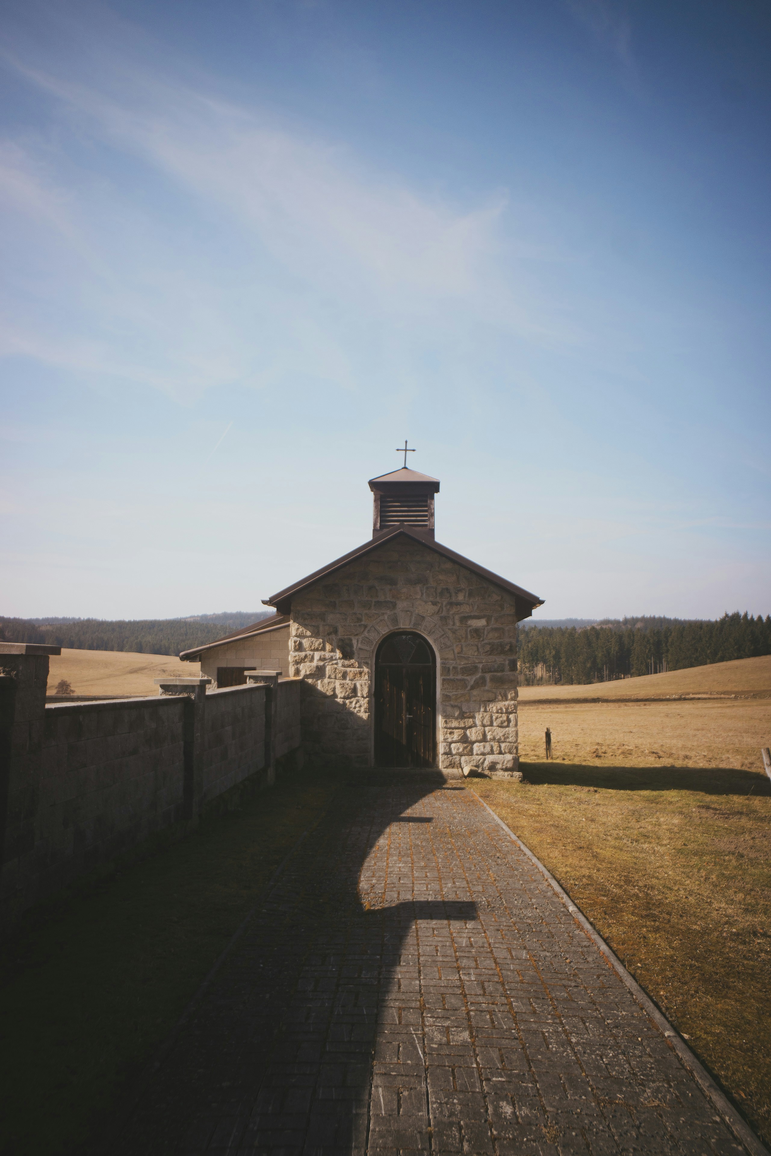 Stone Chapel Amid Open Fields Under a Wide Sky