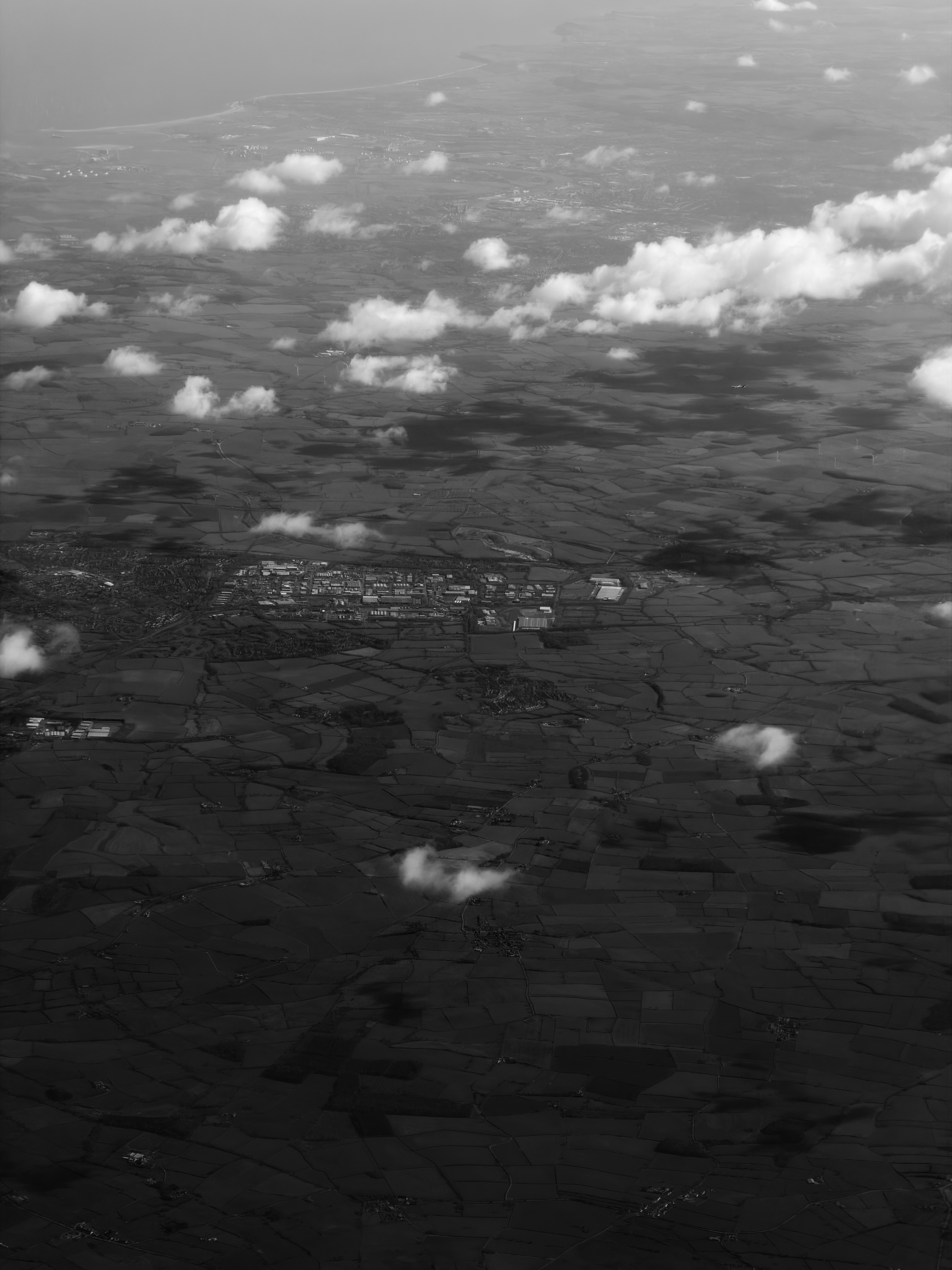 Low-Altitude Fields Quiet Beneath a Clouded Sky