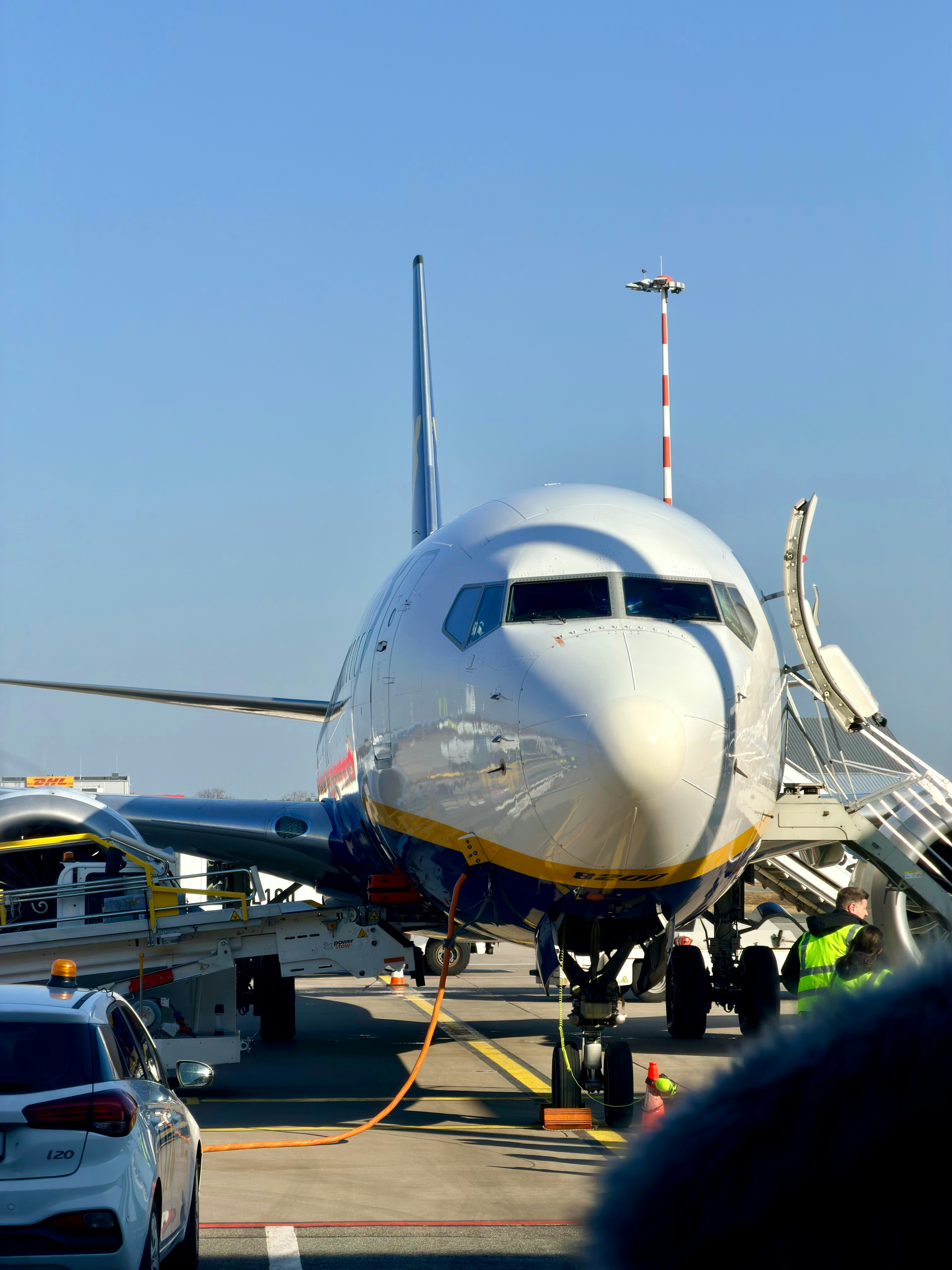 Front-Quarter View of a Jet at Gate, Ground Crew in Action