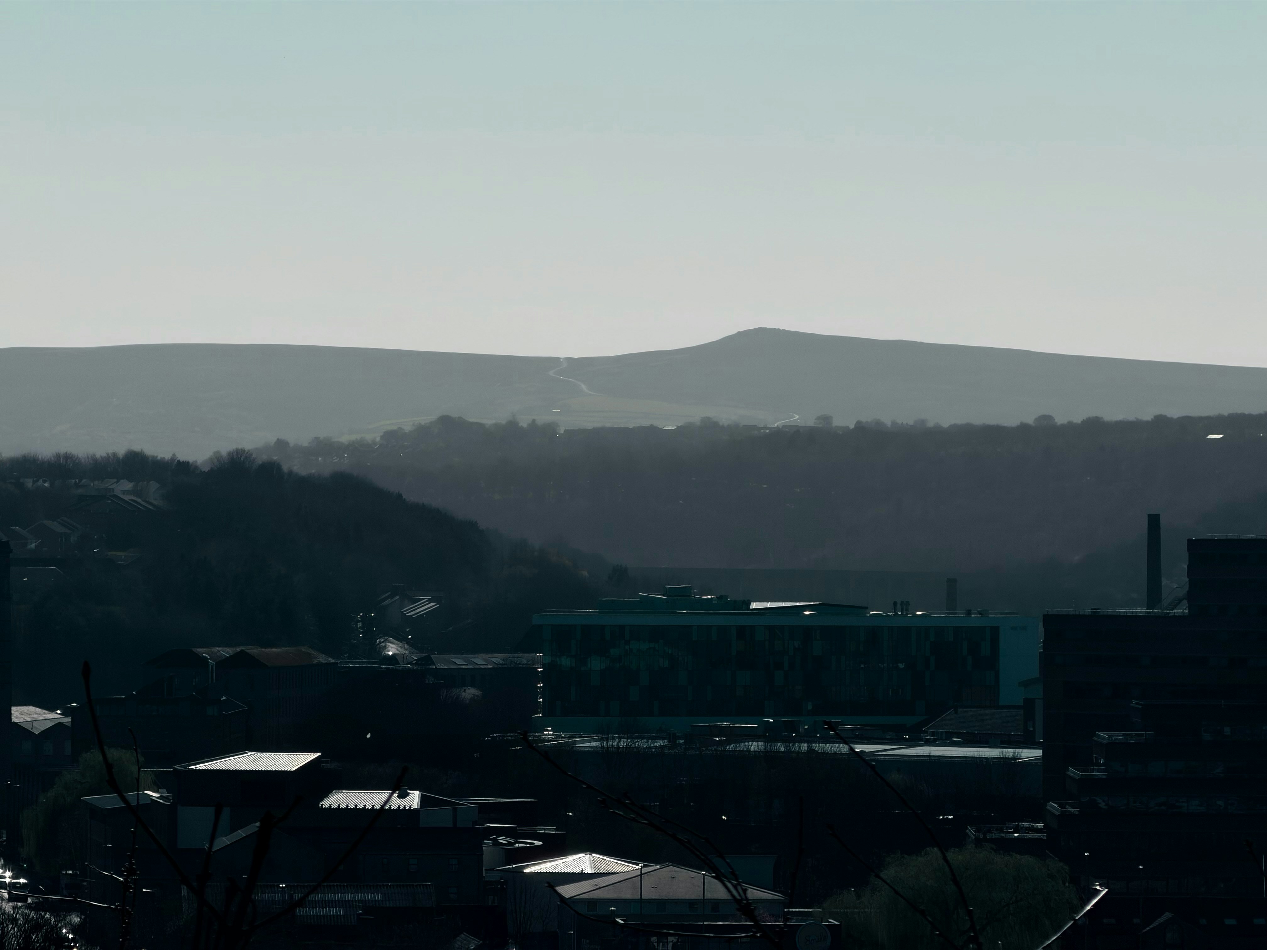 Horizon Staircase: Distant Ridge Over a Quiet Cityscape