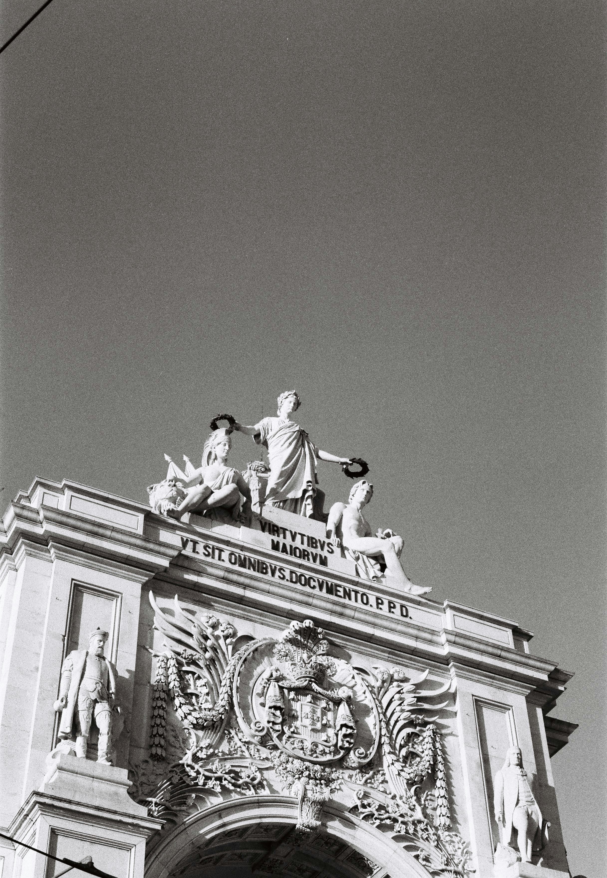 Sculpted podium of triumph: architectural relief crowned with figures
