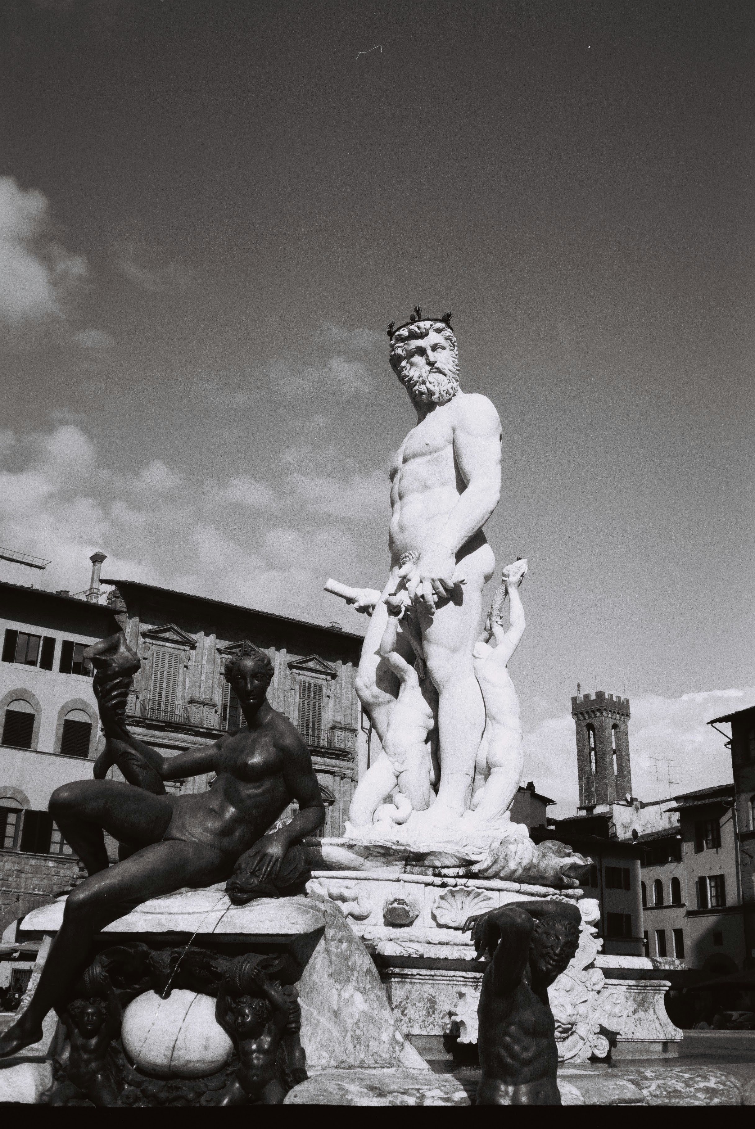 Stone Titan: A Classical Fountain Surrounded by Urban Echoes