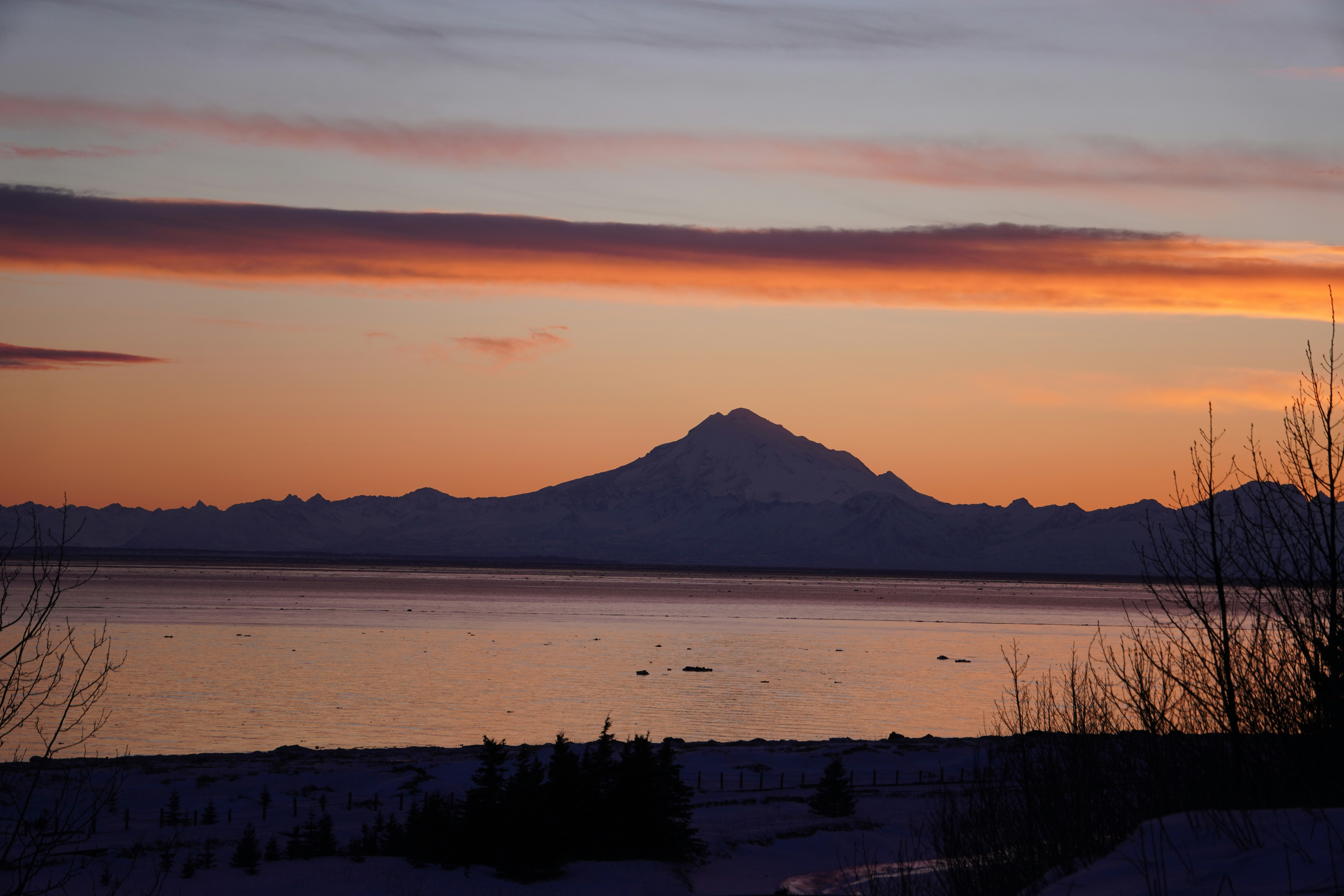 Dawn Over the Snow-Capped Peak Beyond a Silent Lake