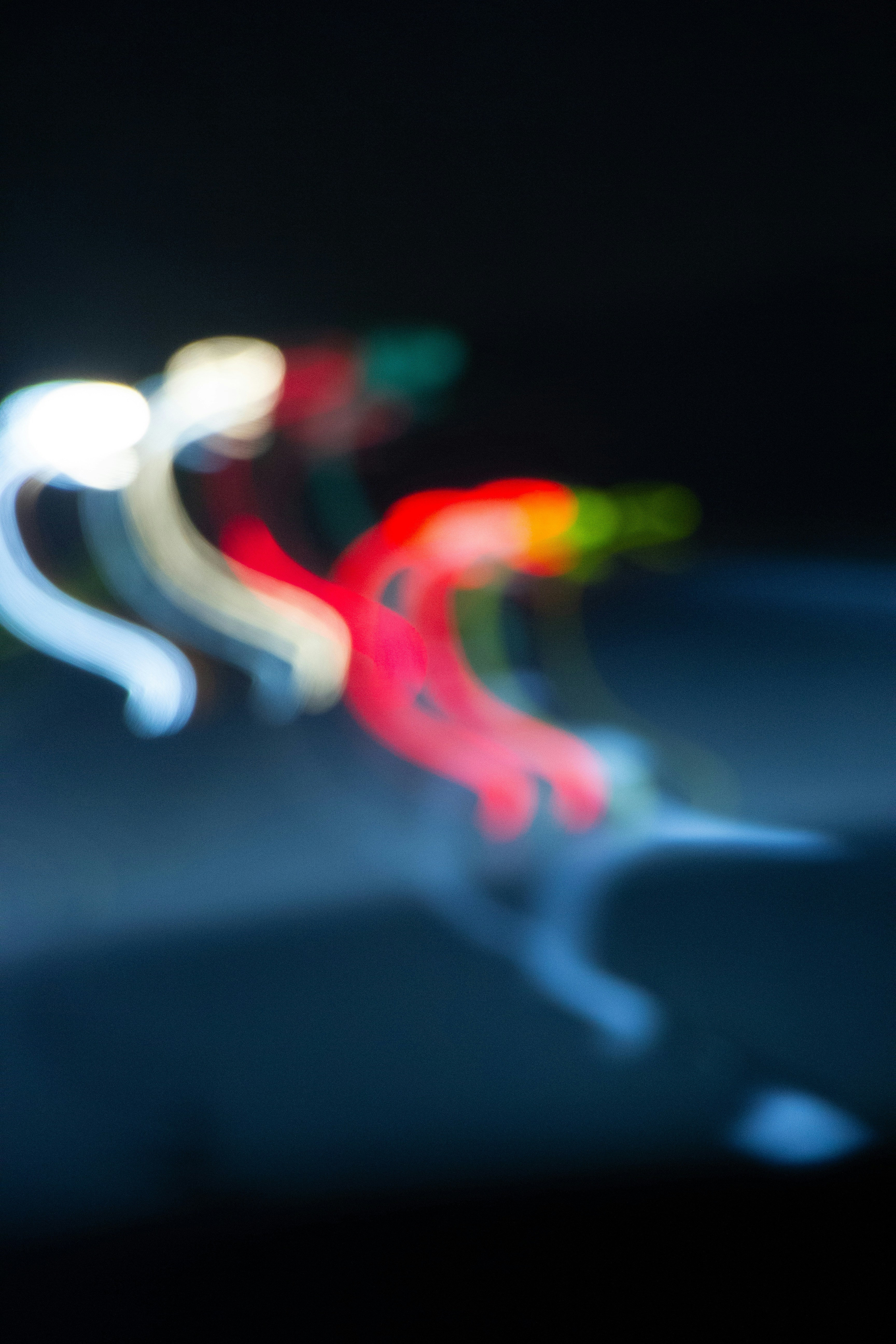 Neon Echoes: Blurred Streetlight Trails in Night Blue