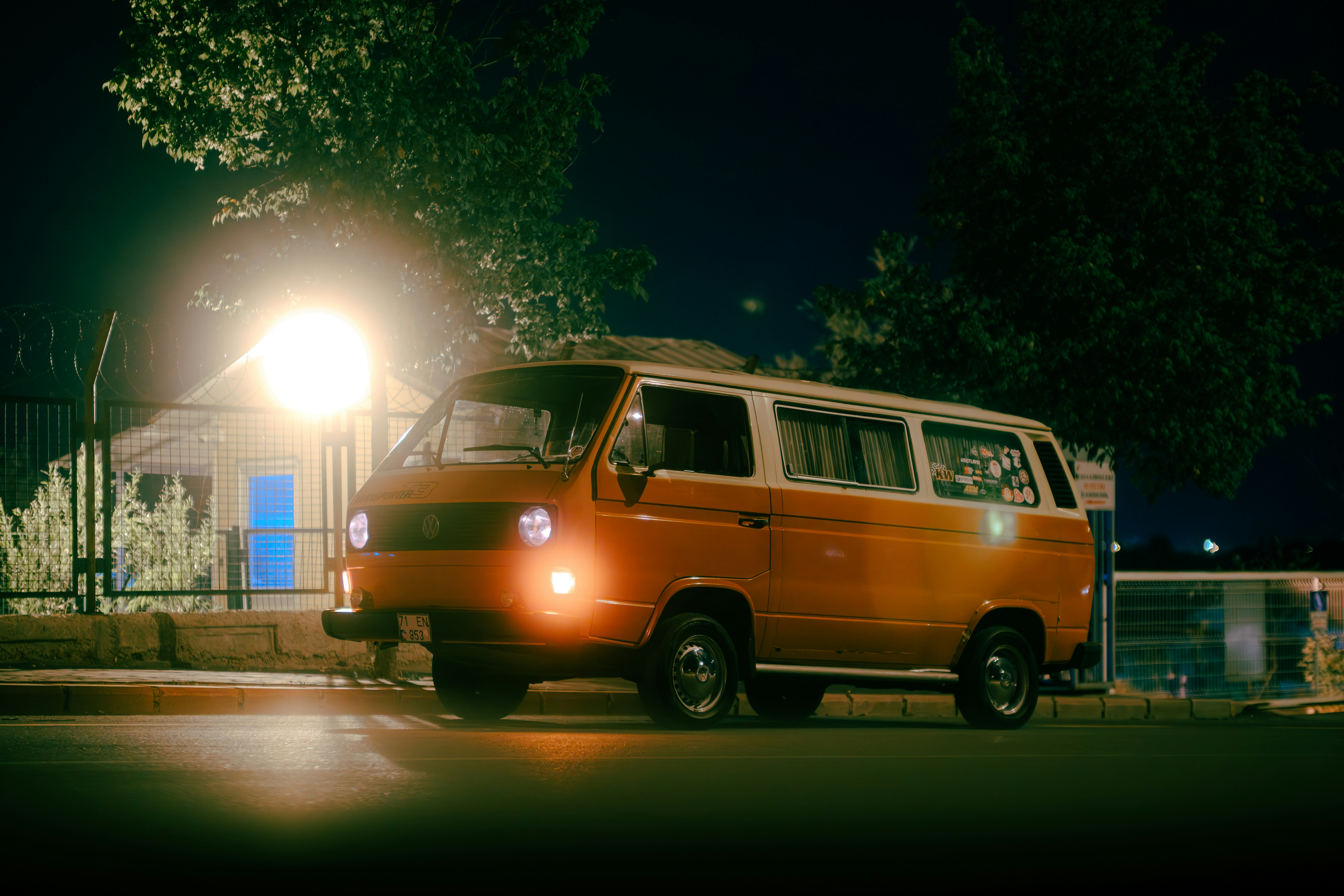 Midnight Retro: Orange VW Van Under Streetlamp Glow