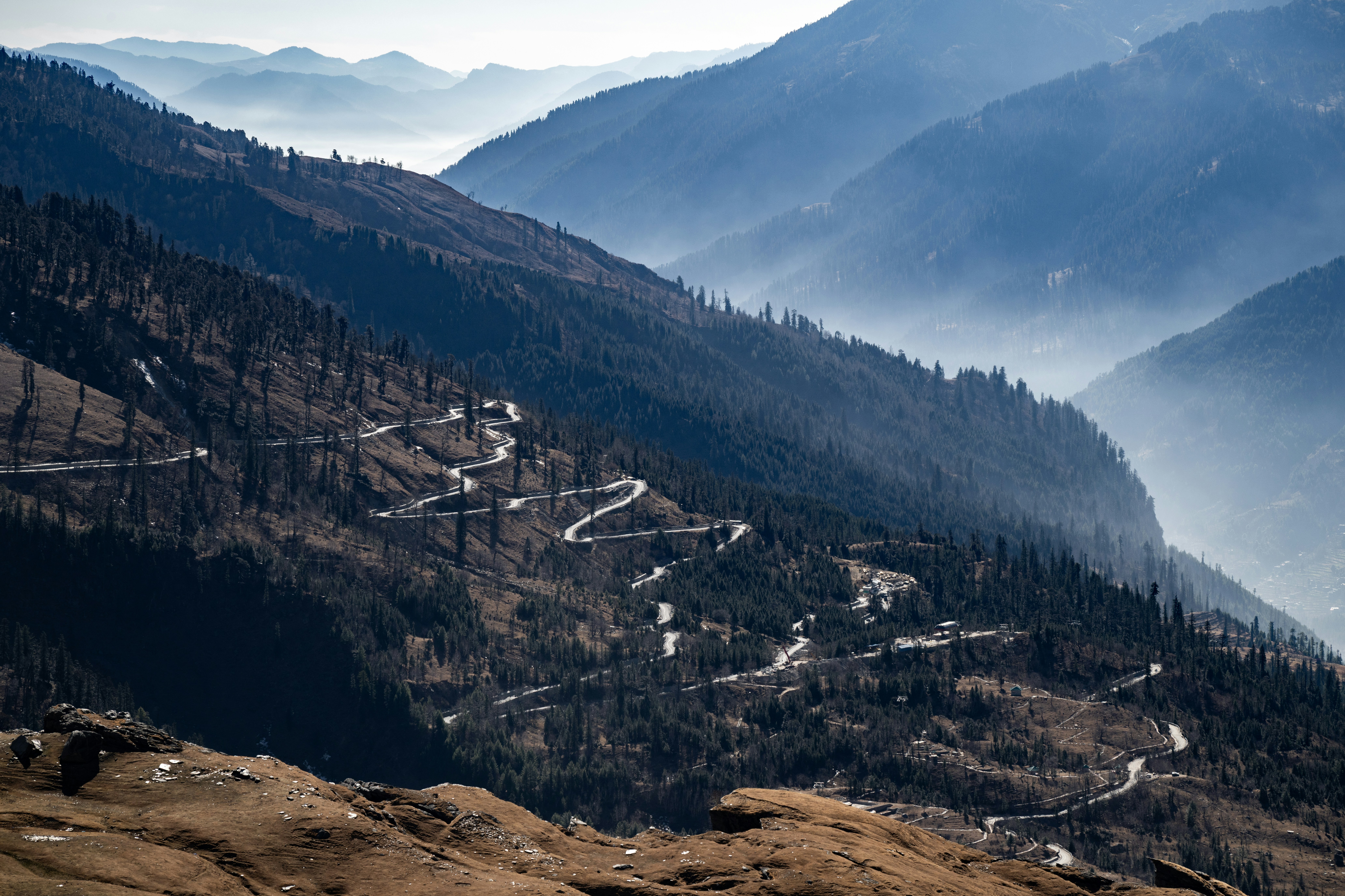 Winding Switchbacks Carving Light Across a Mountain Valley