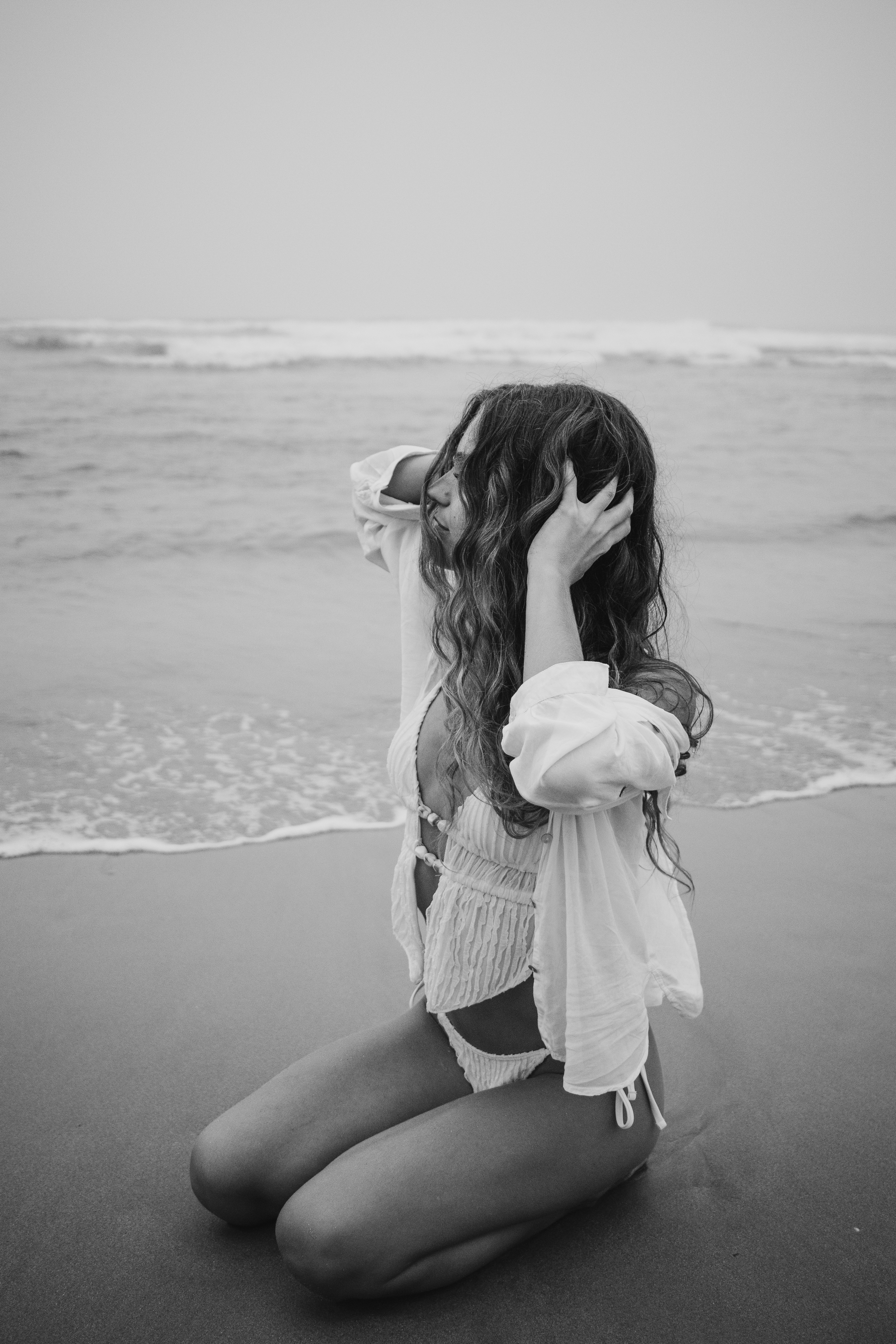 Mid Beach Reverie: A Woman in White on the Tide