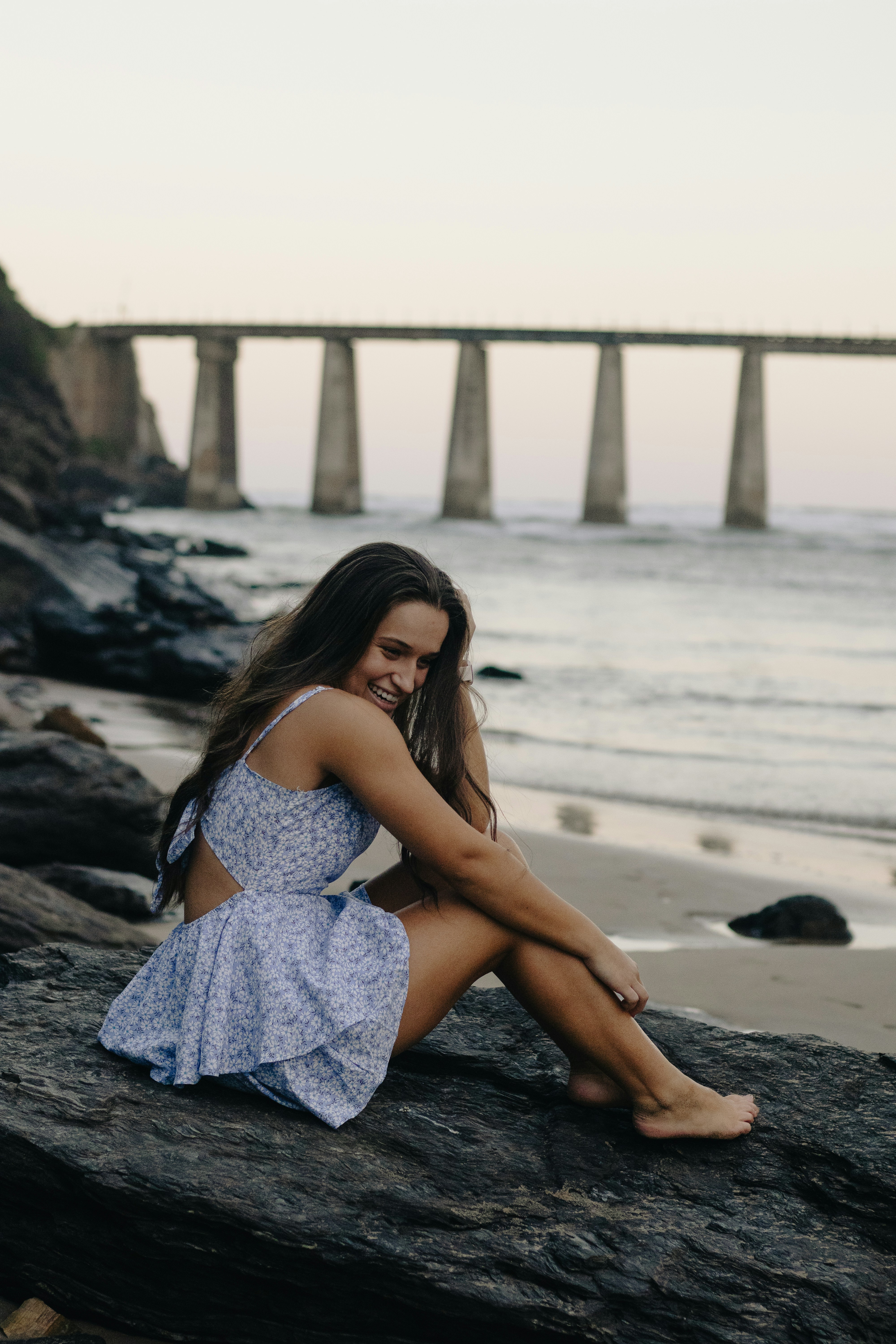Smiling in the Shallows: A Seaside Moment by the Pier