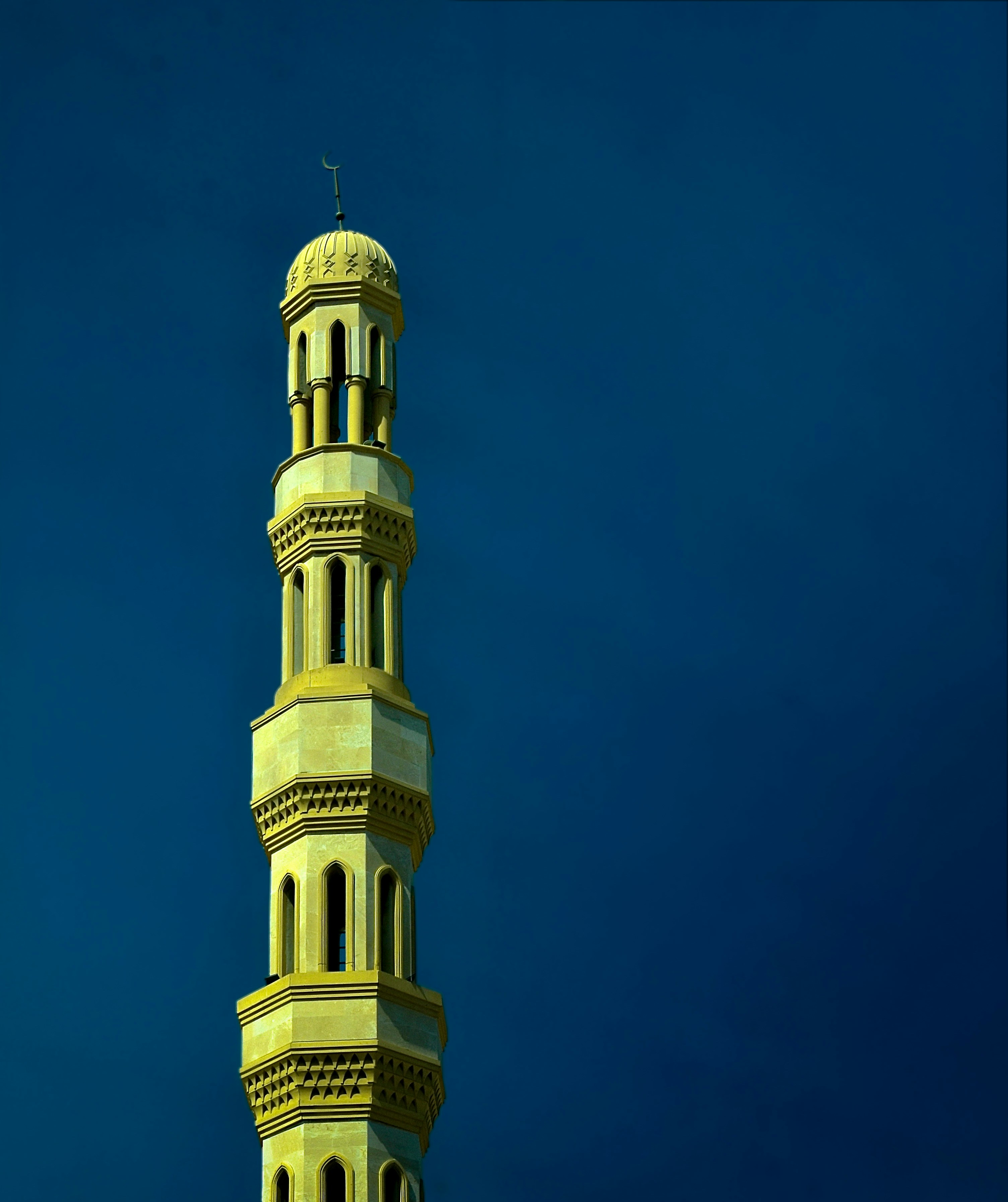 Spire in Azure: An Illuminated Minaret Reaches Skyward