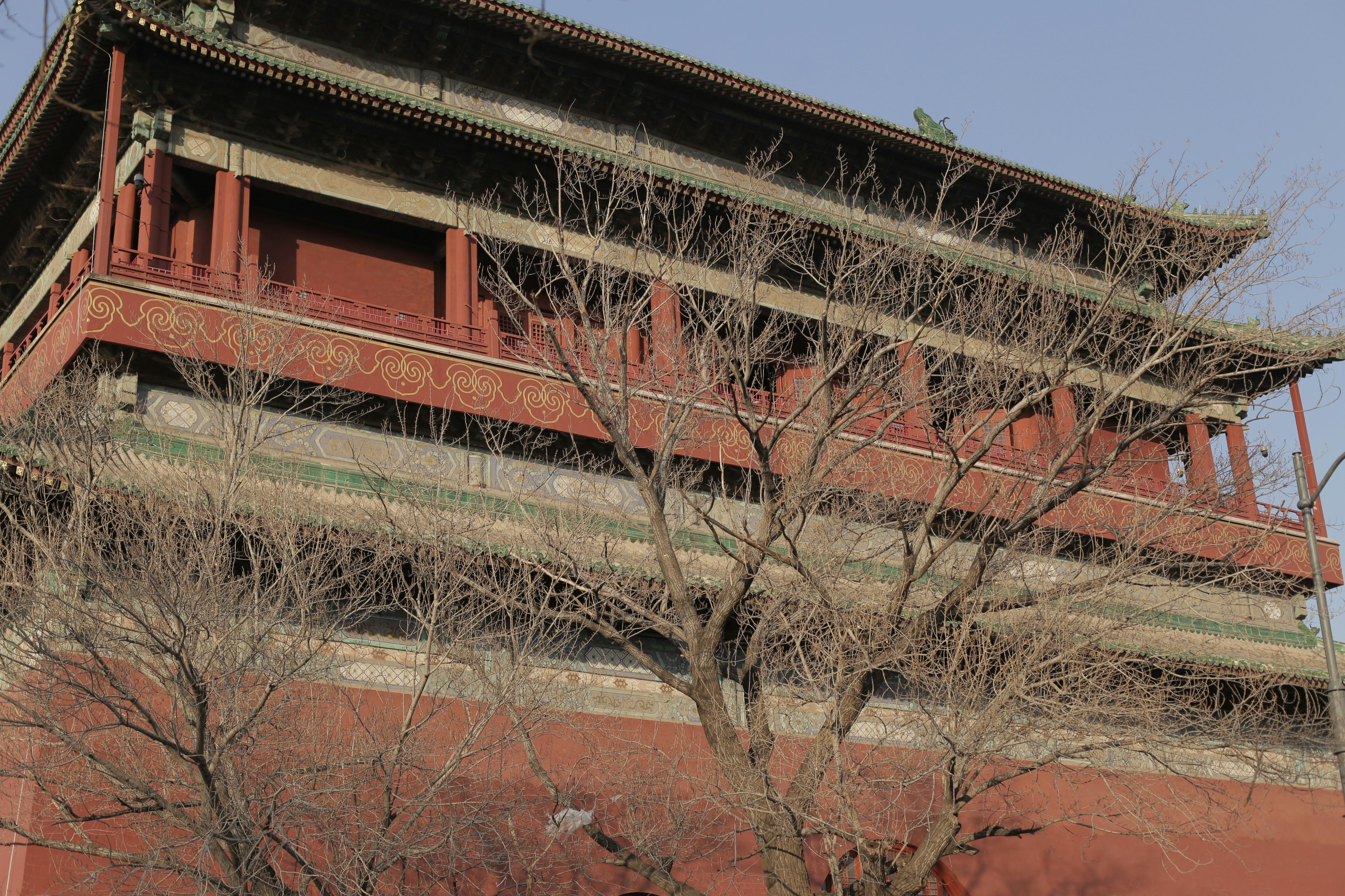 Red Fortress Rooftop: A Closer Look at Painted Timber and Bare Branches