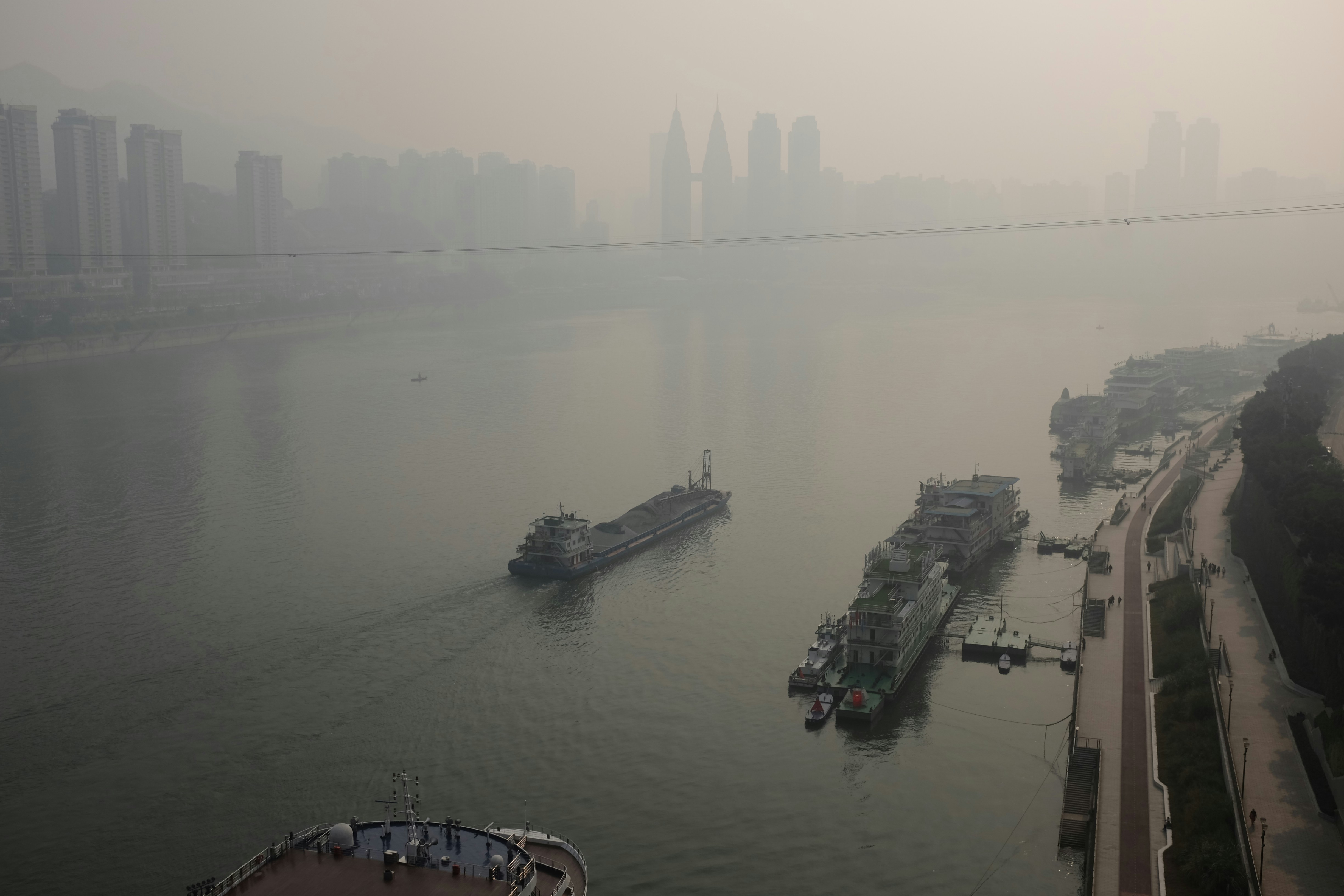 Morning Mist Over the River: Boats and Skyline in Soft Light