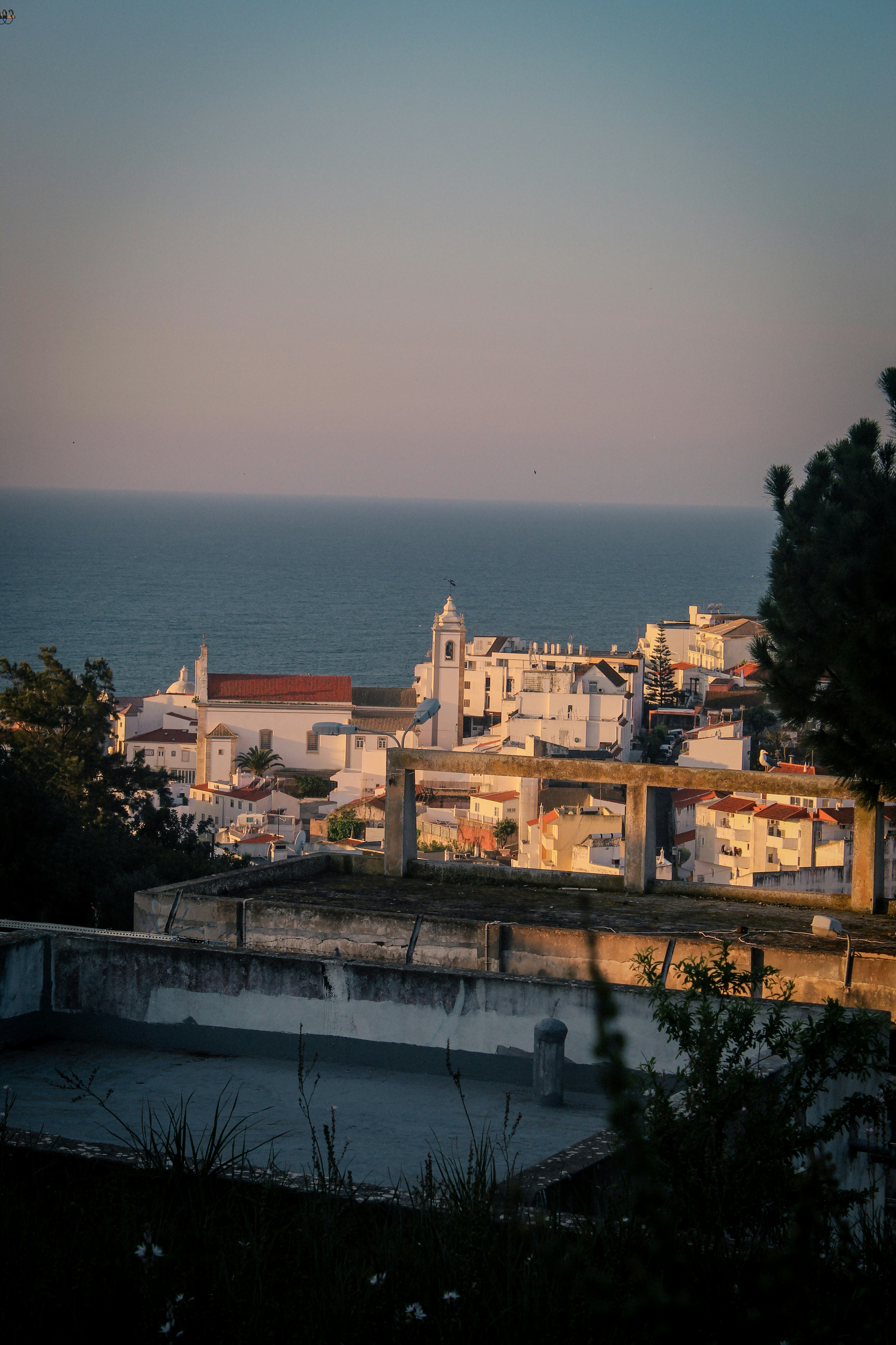 Sunlit coastal town perched on a tiered hillside