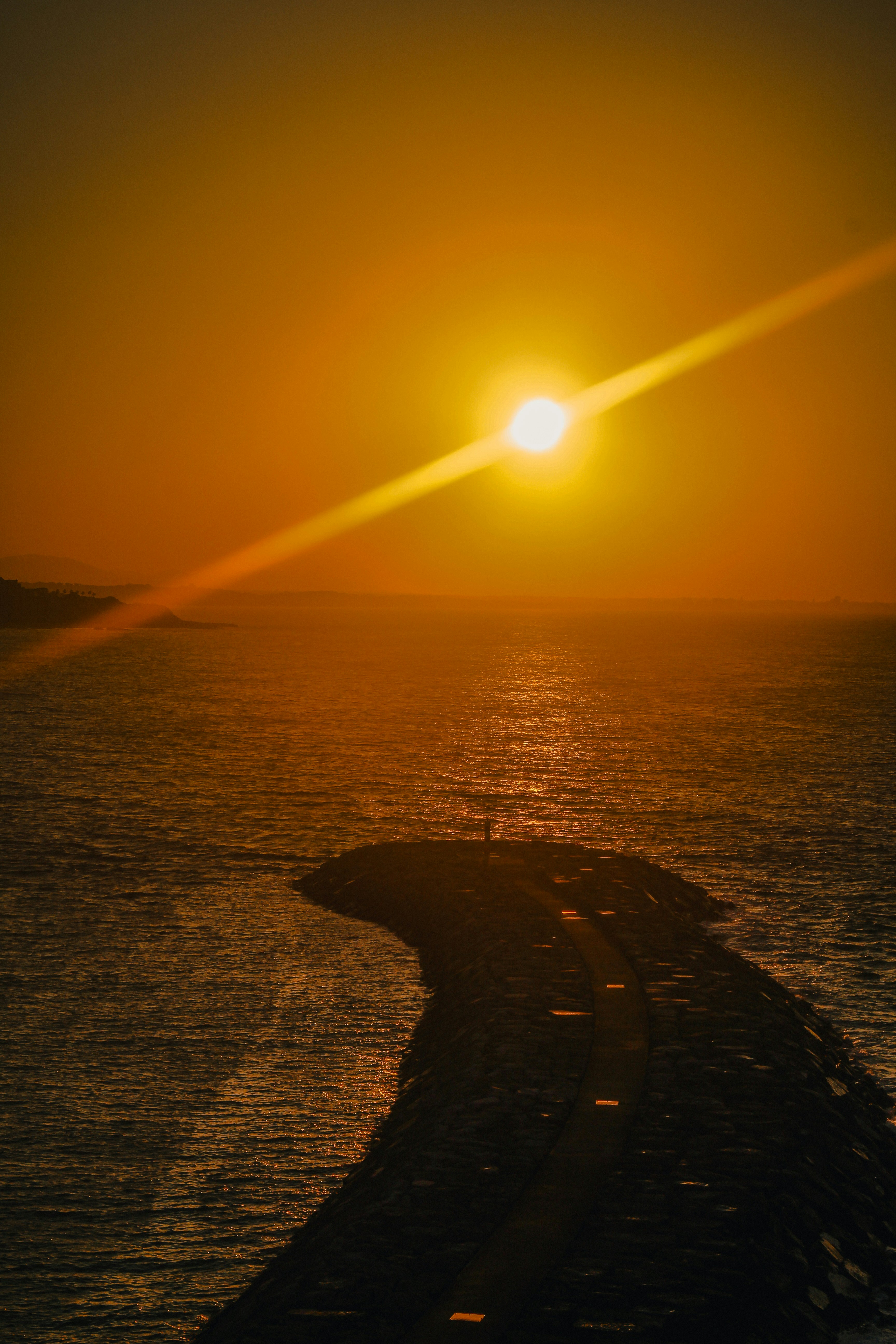 Sunset Pier: A Fiery Path Over Quiet Waters
