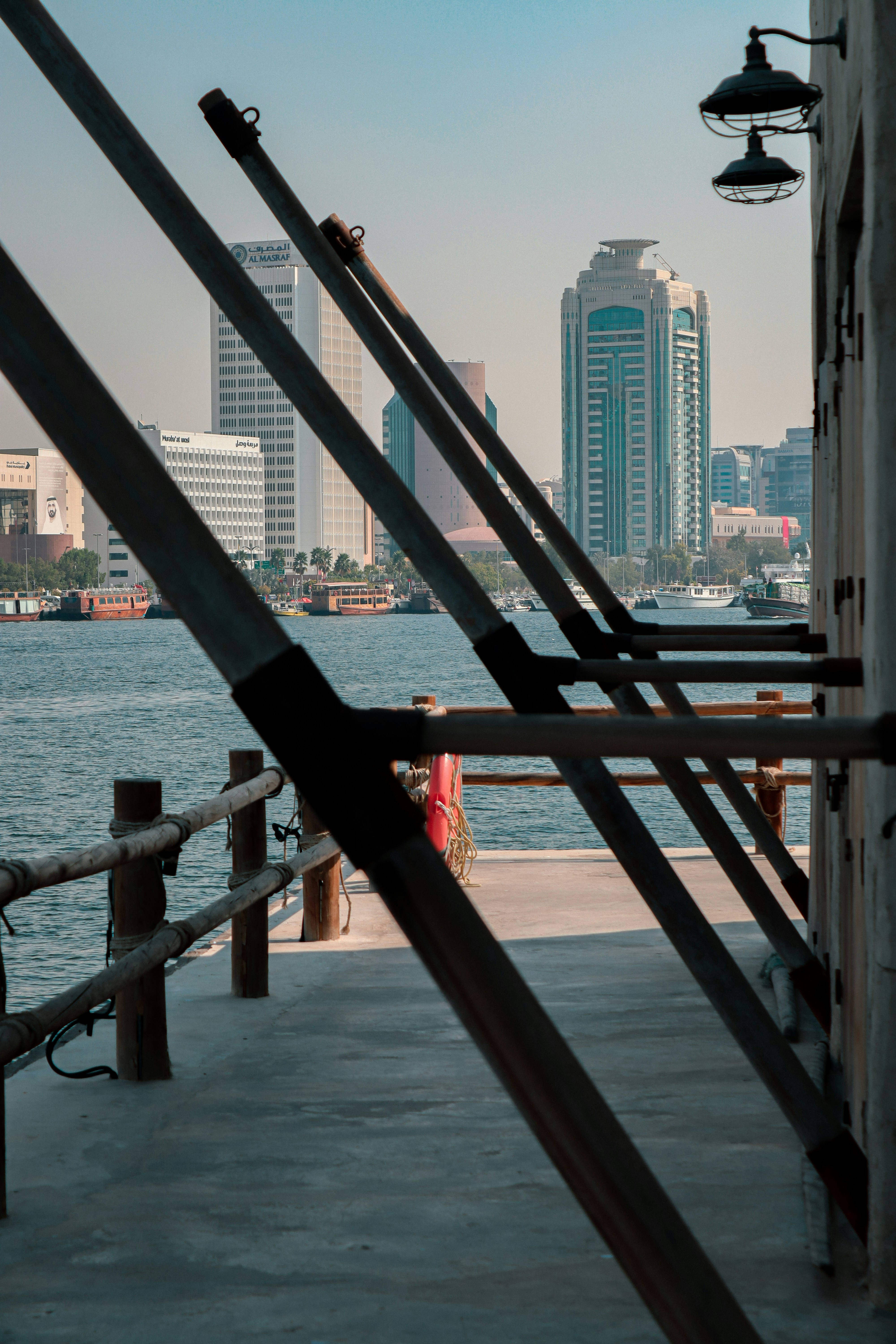 Seafront Arches: Modern Towers Framed by Waterfront Railings