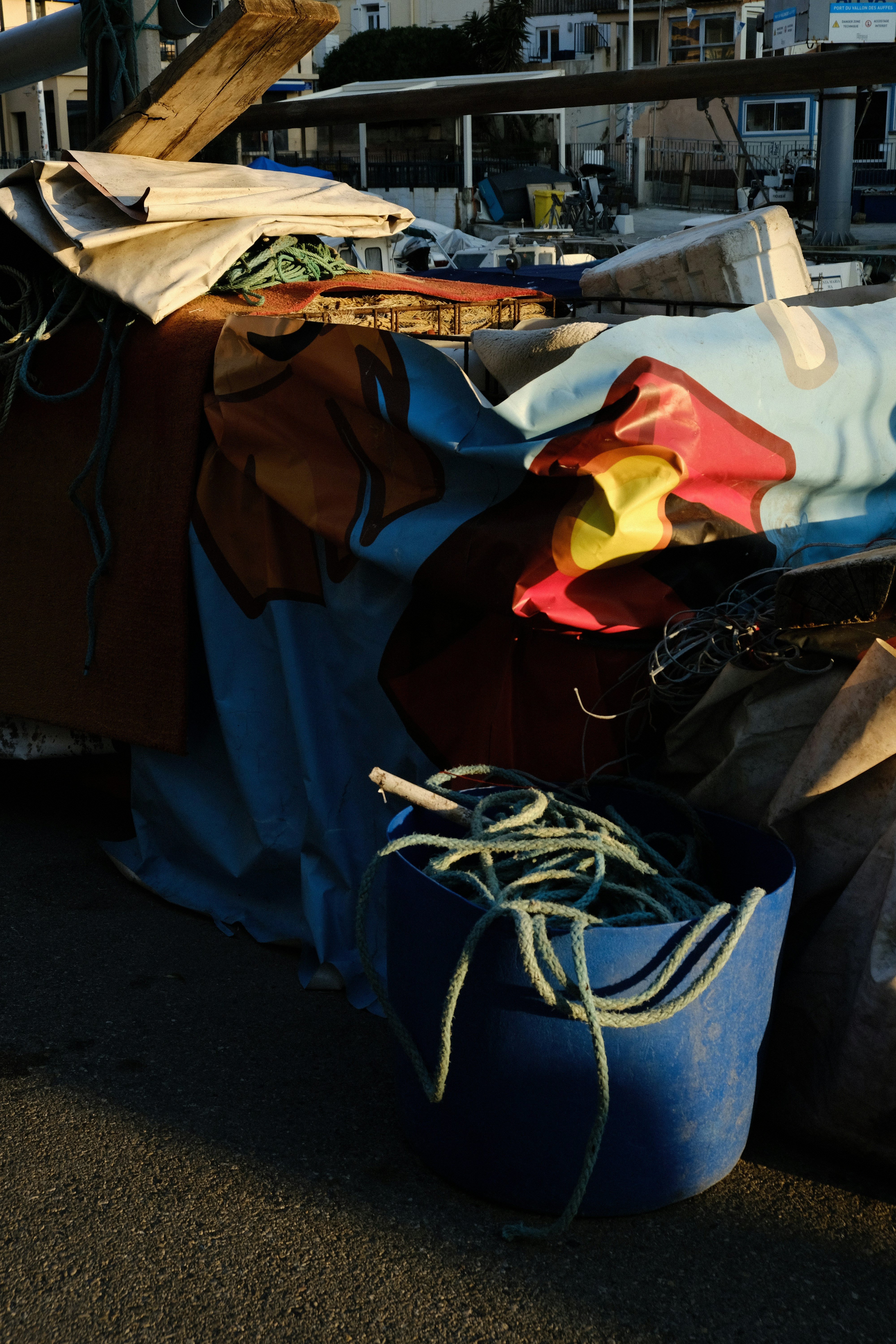 Coiled ropes and Sunlit Gear Beneath a Sailcloth Tarp