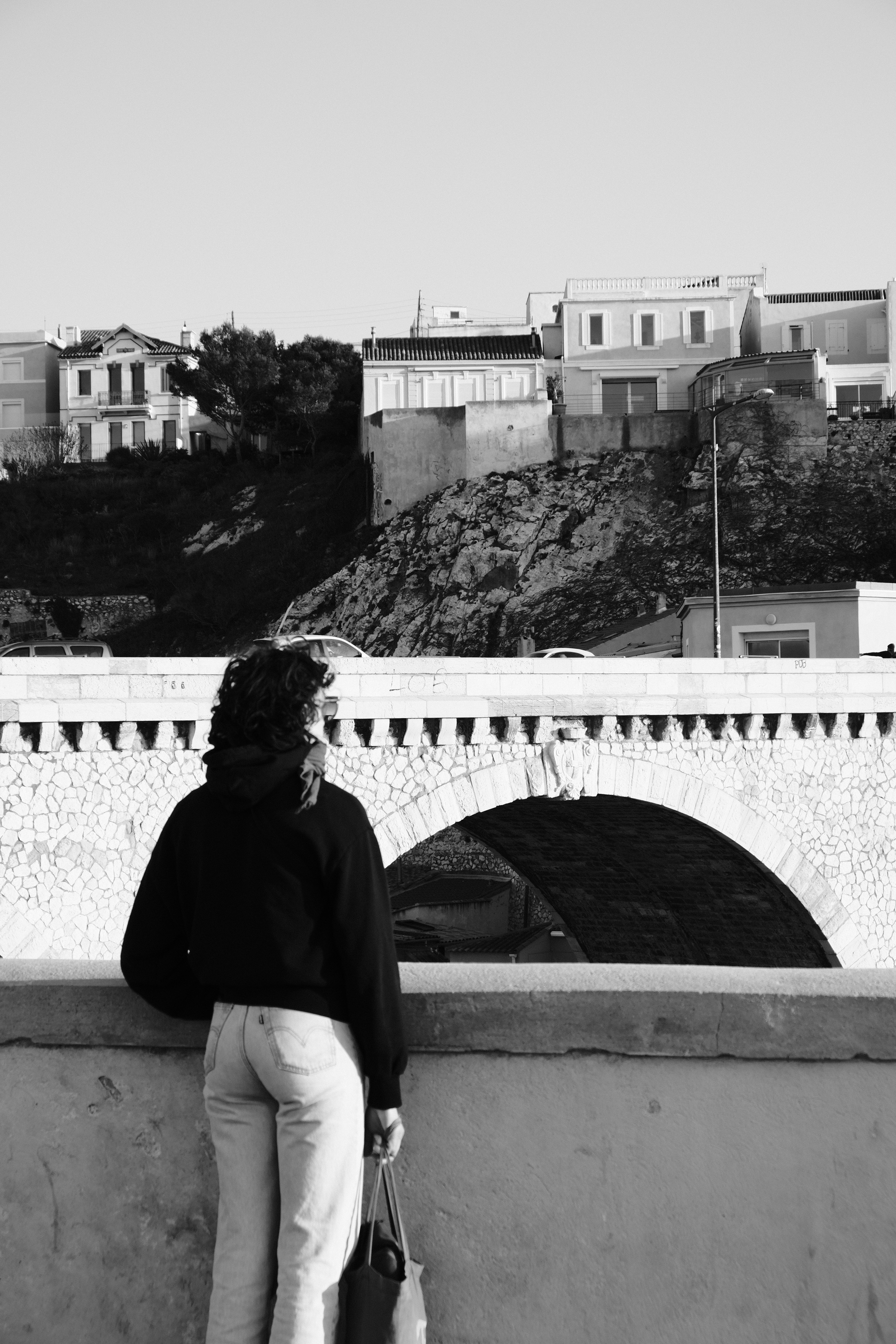 Bridge of Quiet Steps: A lone figure roams the railing
