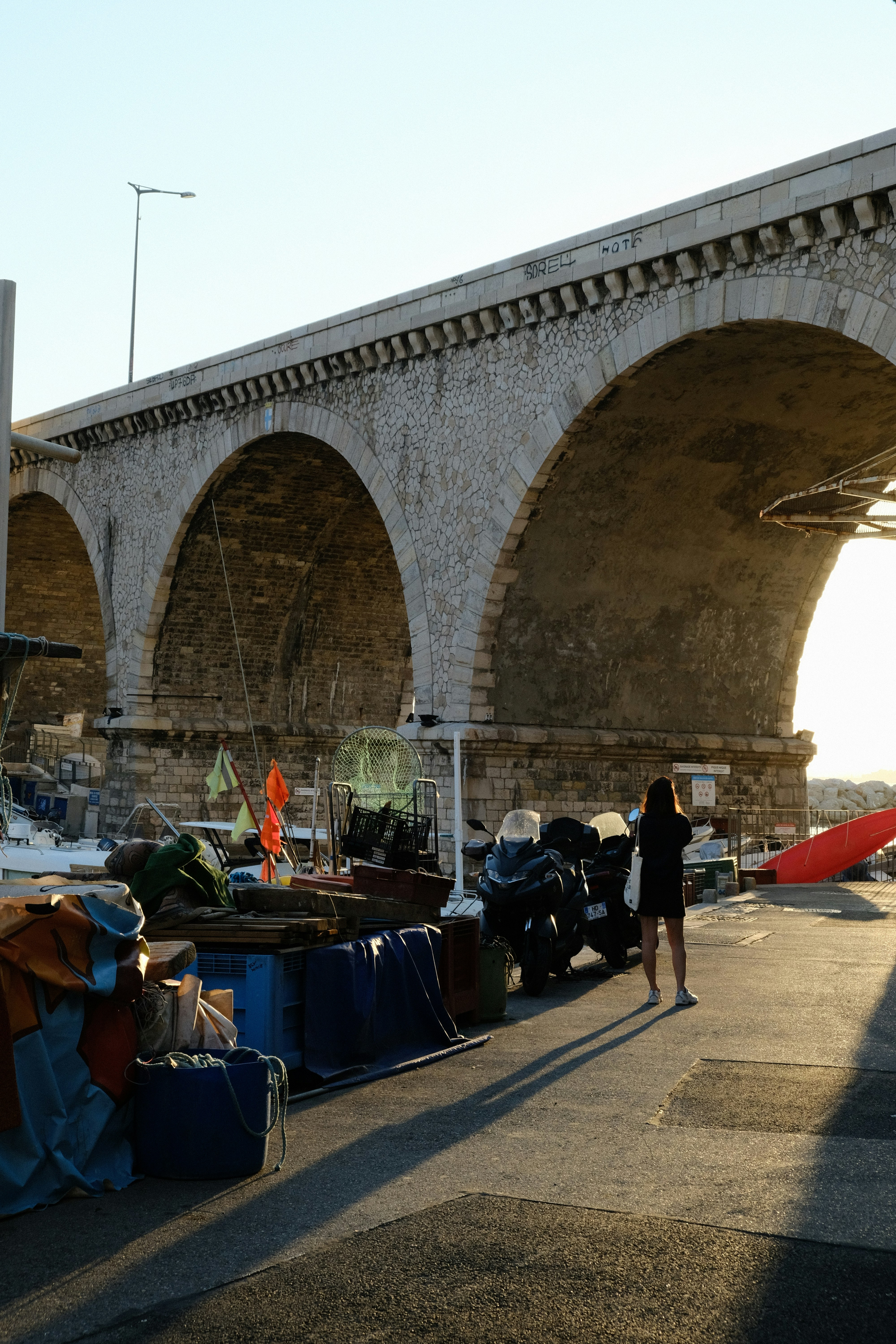Sunlit Harbor Market Under the Arches