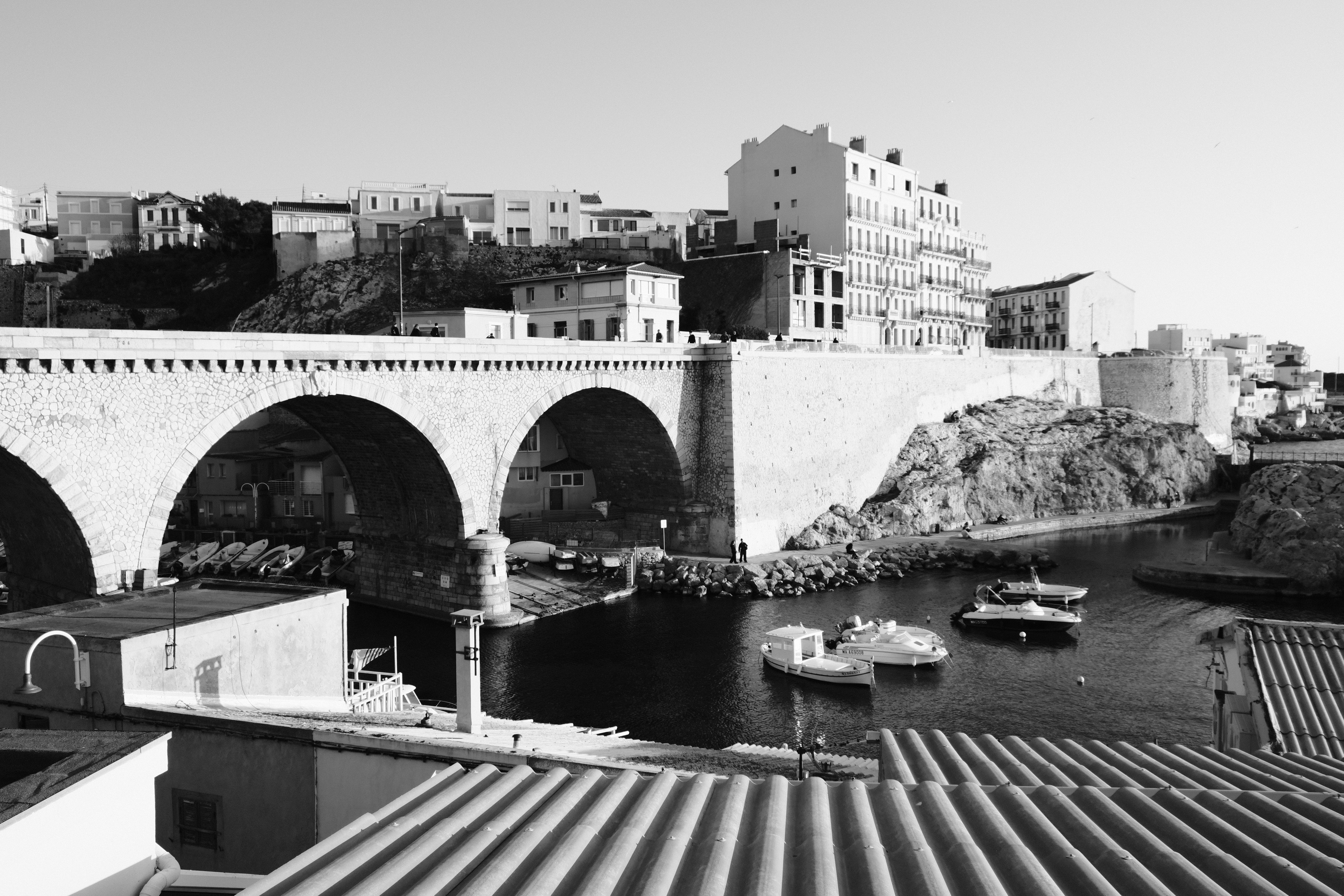 Stone Arches over a Quiet Harbor: A Coastal Town’s Timeless Flow