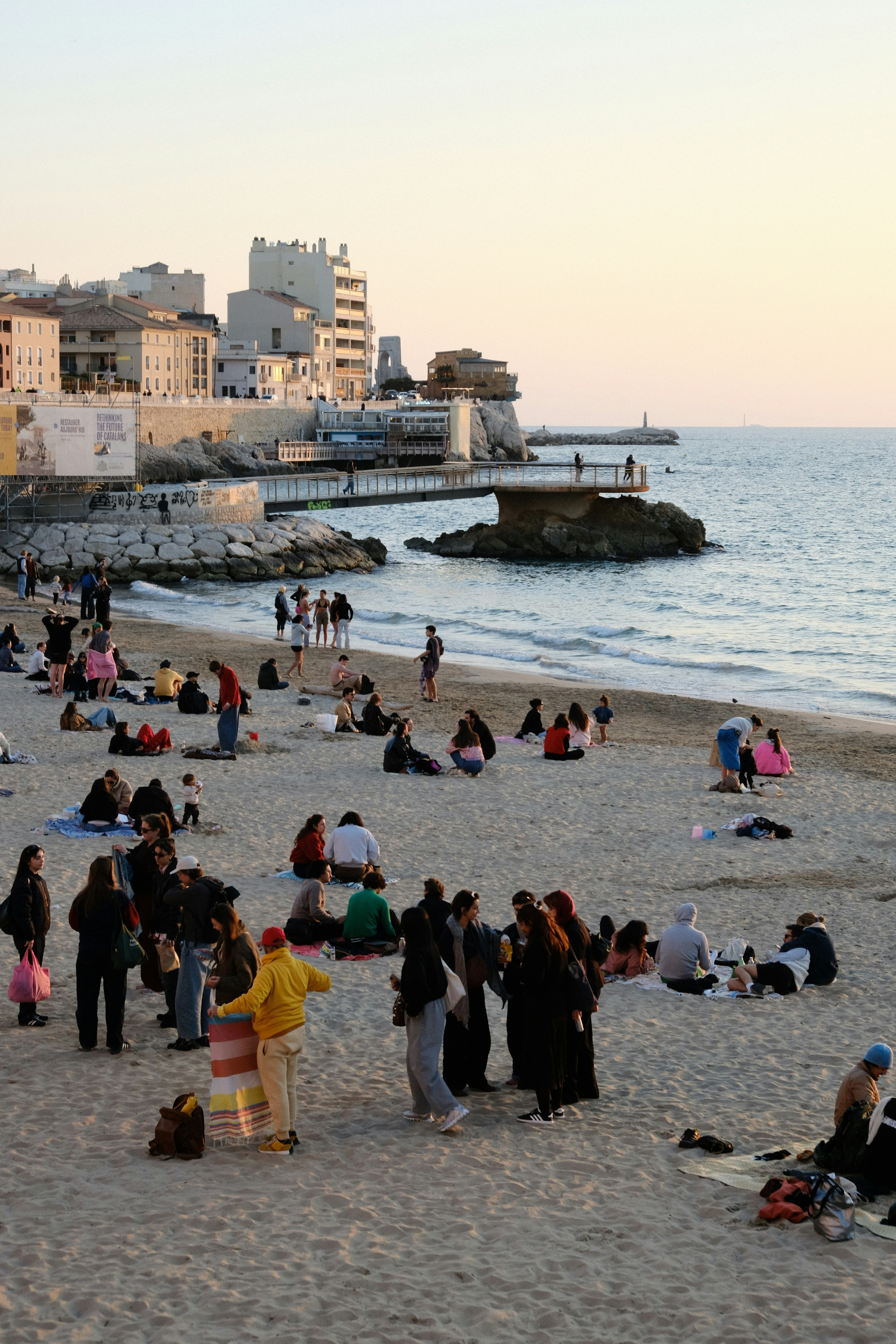 Sunlit Coastal Crowd: A Quiet Afternoon on the Beach