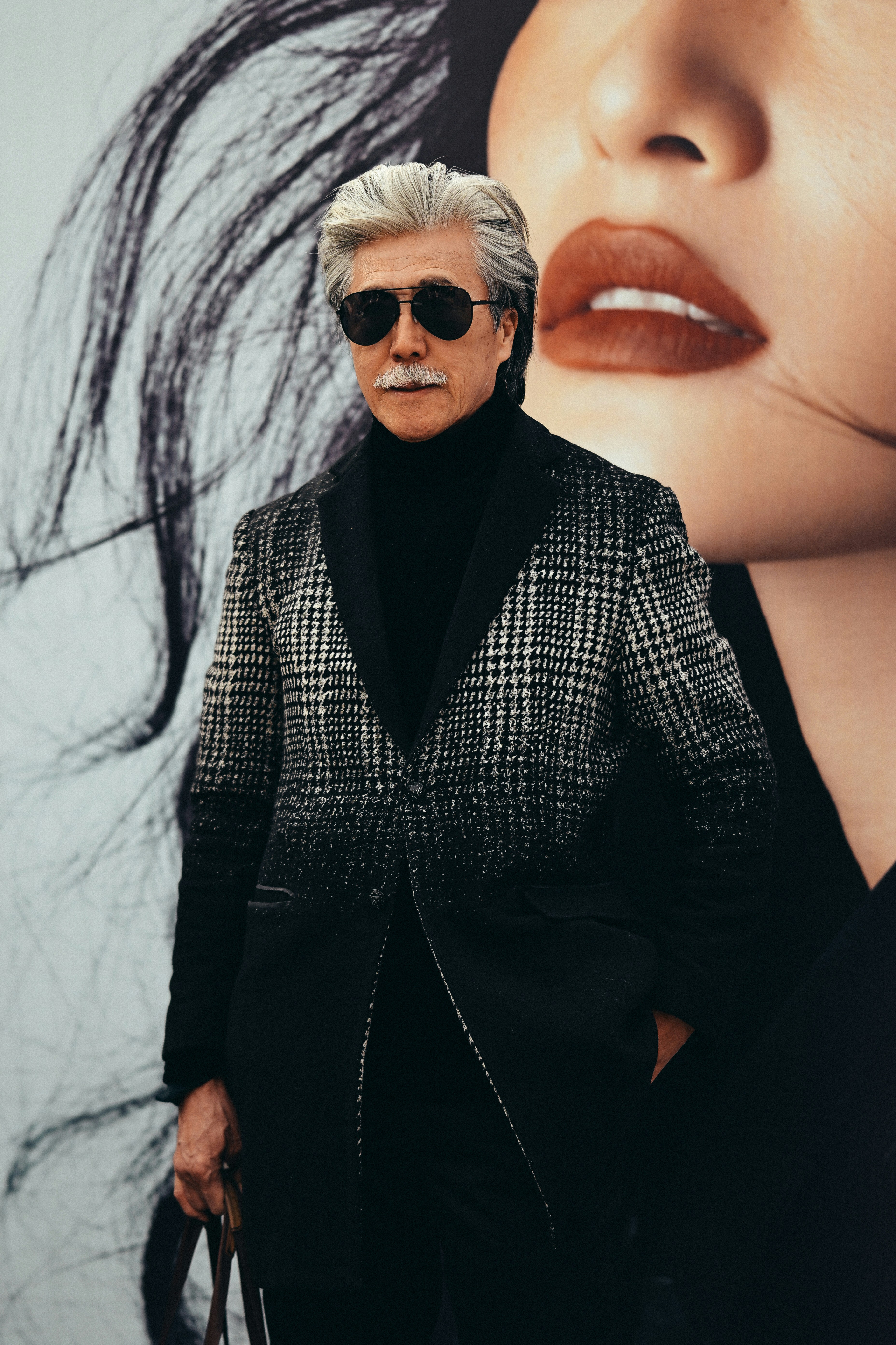 Portrait of Presence: A Dapper Icon Against a Split-Faced Backdrop