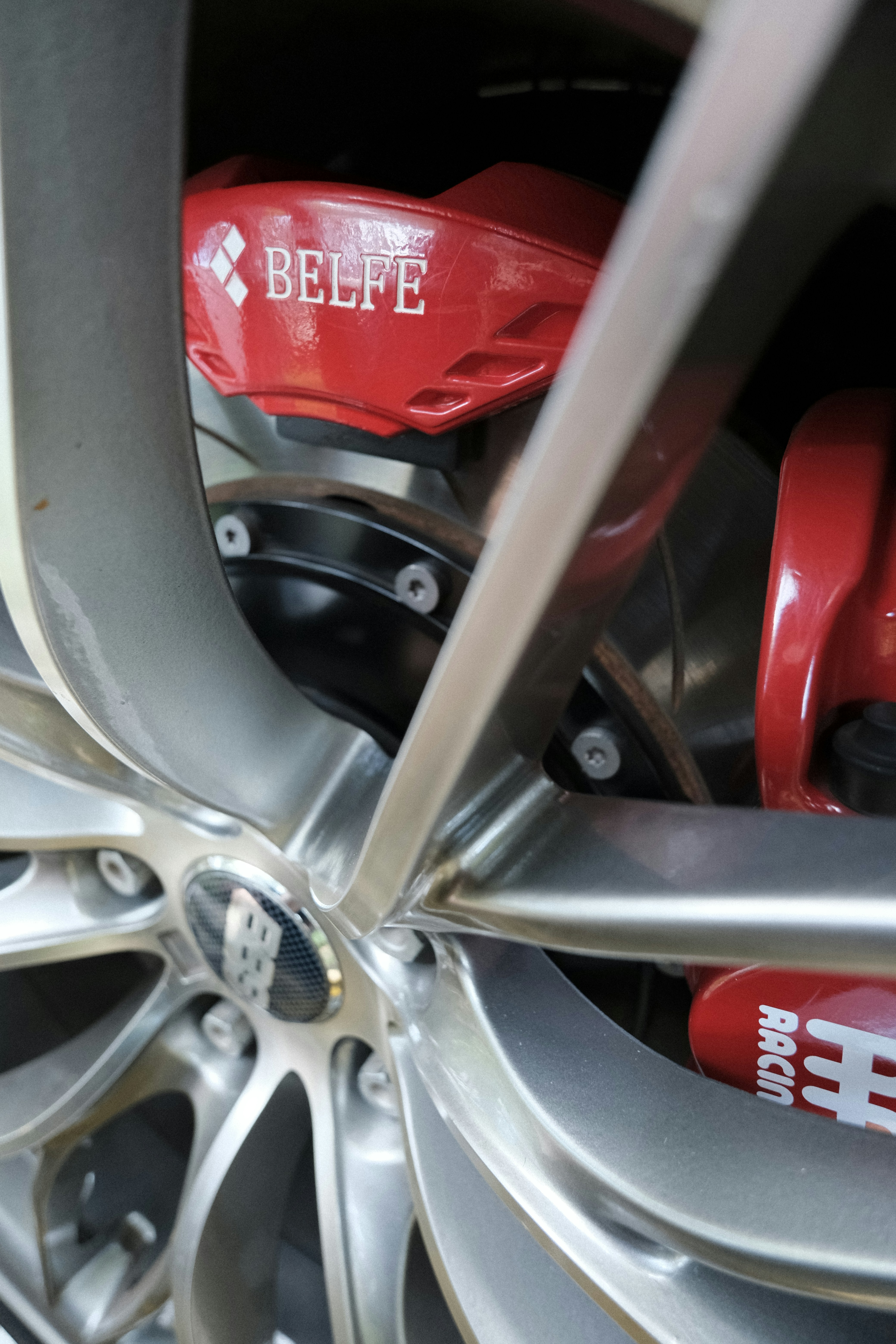Red Rimmed Velocity: Close-Up of a Brembo-Caliper Clasping a Wheel