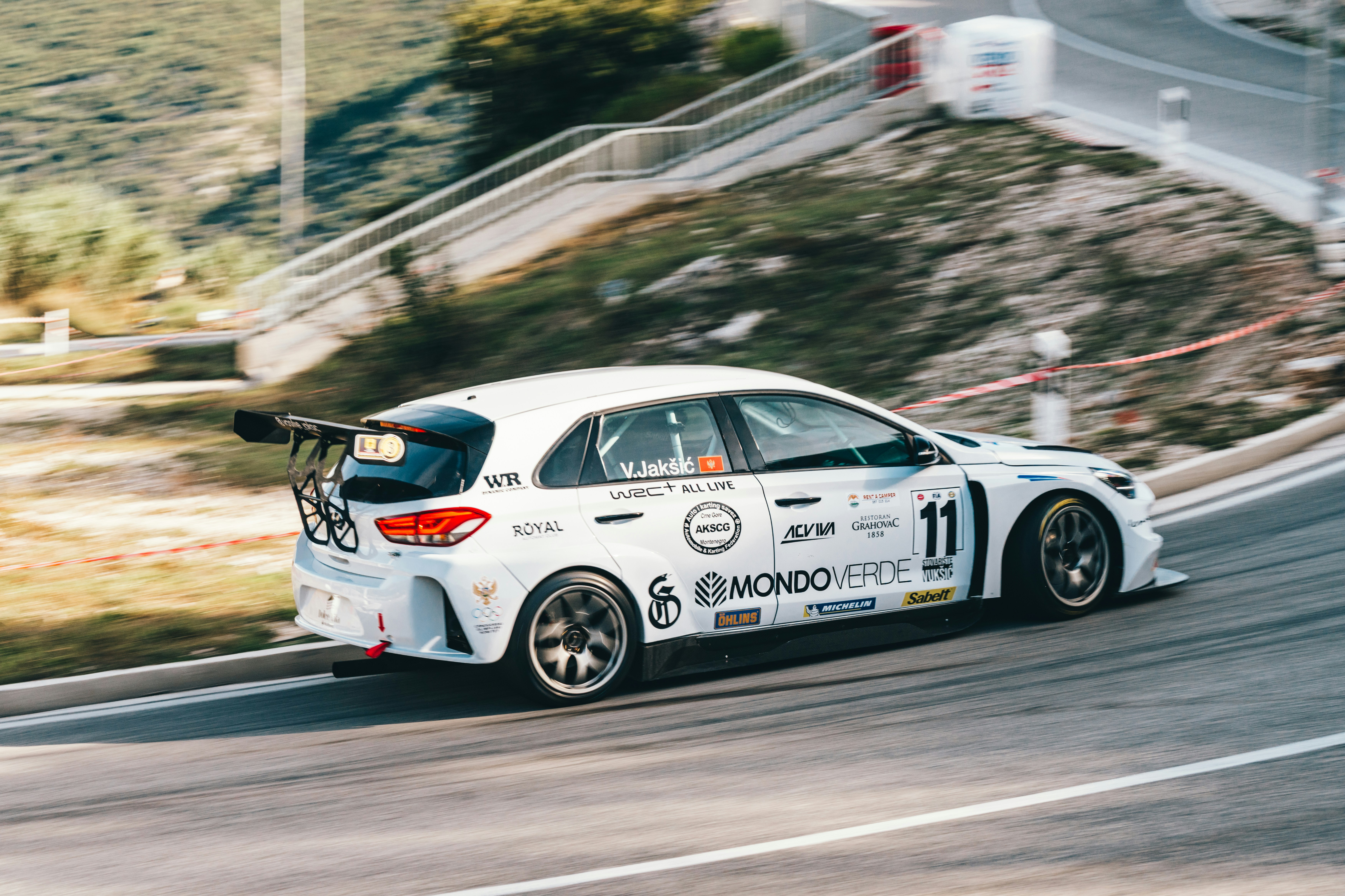 Sprint Through the Bend: White Race Car in Sharp Turn
